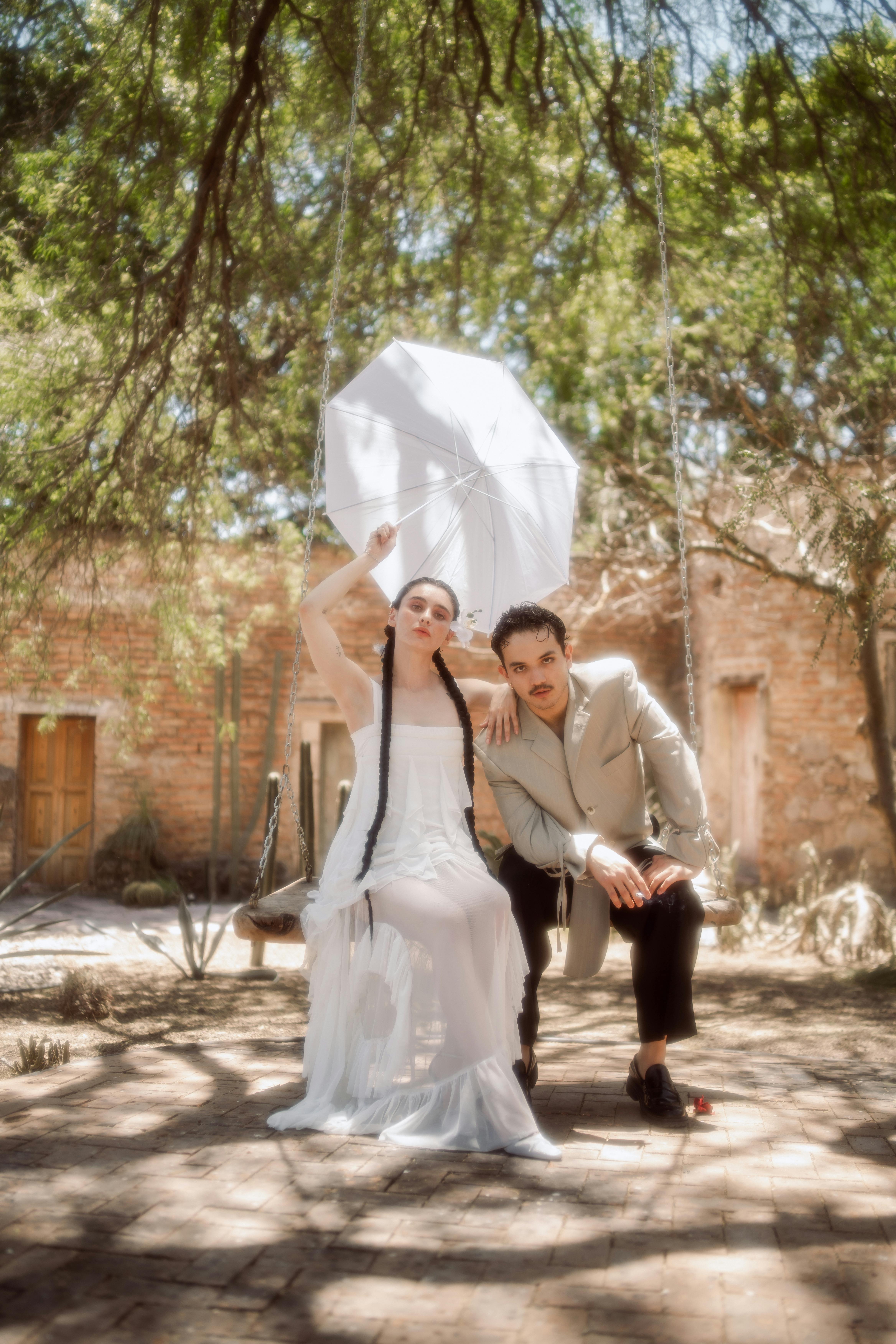 Couple in Vintage Fashion with Parasol Outdoors · Free Stock Photo