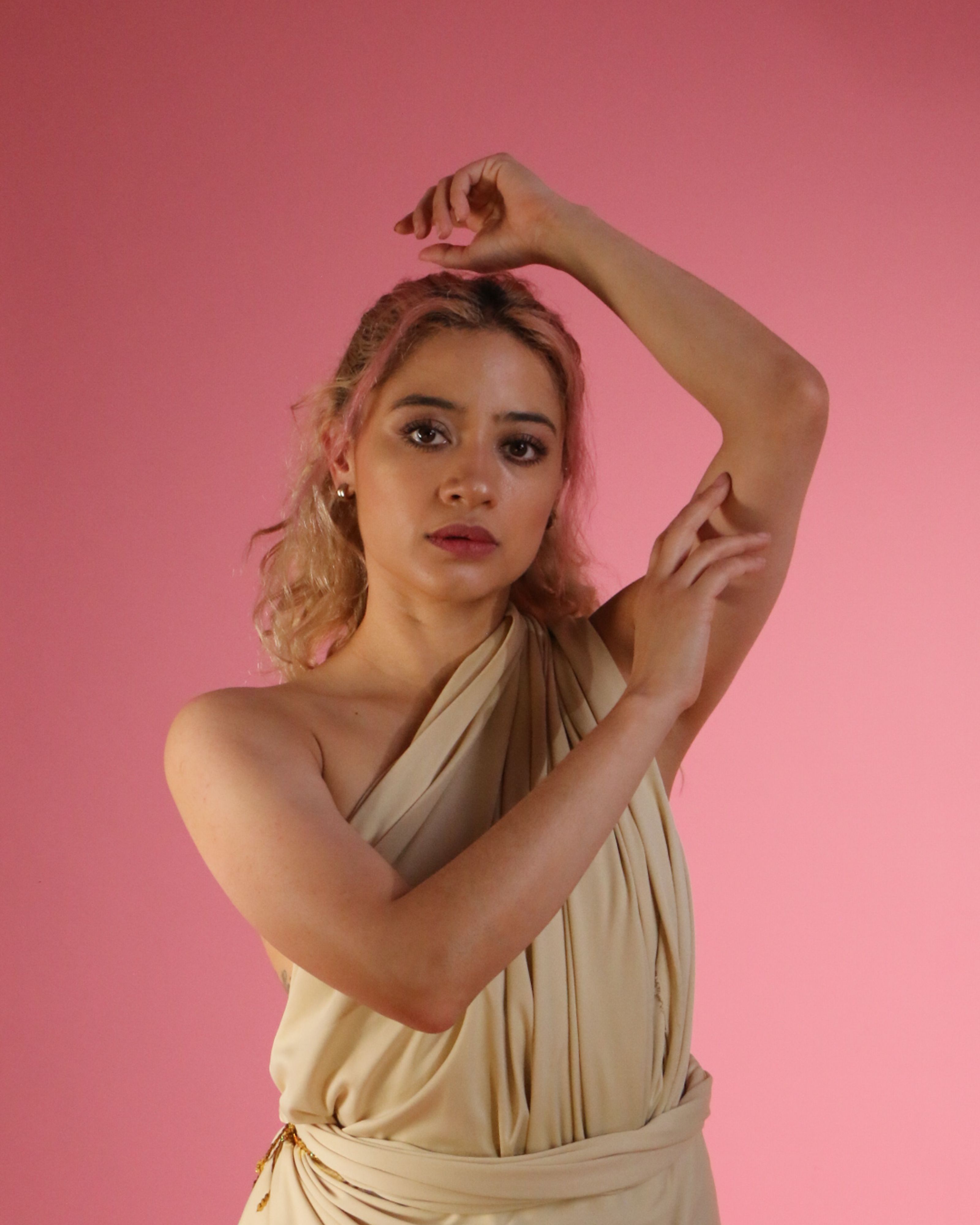 Elegant Woman Posing Against Pink Backdrop · Free Stock Photo