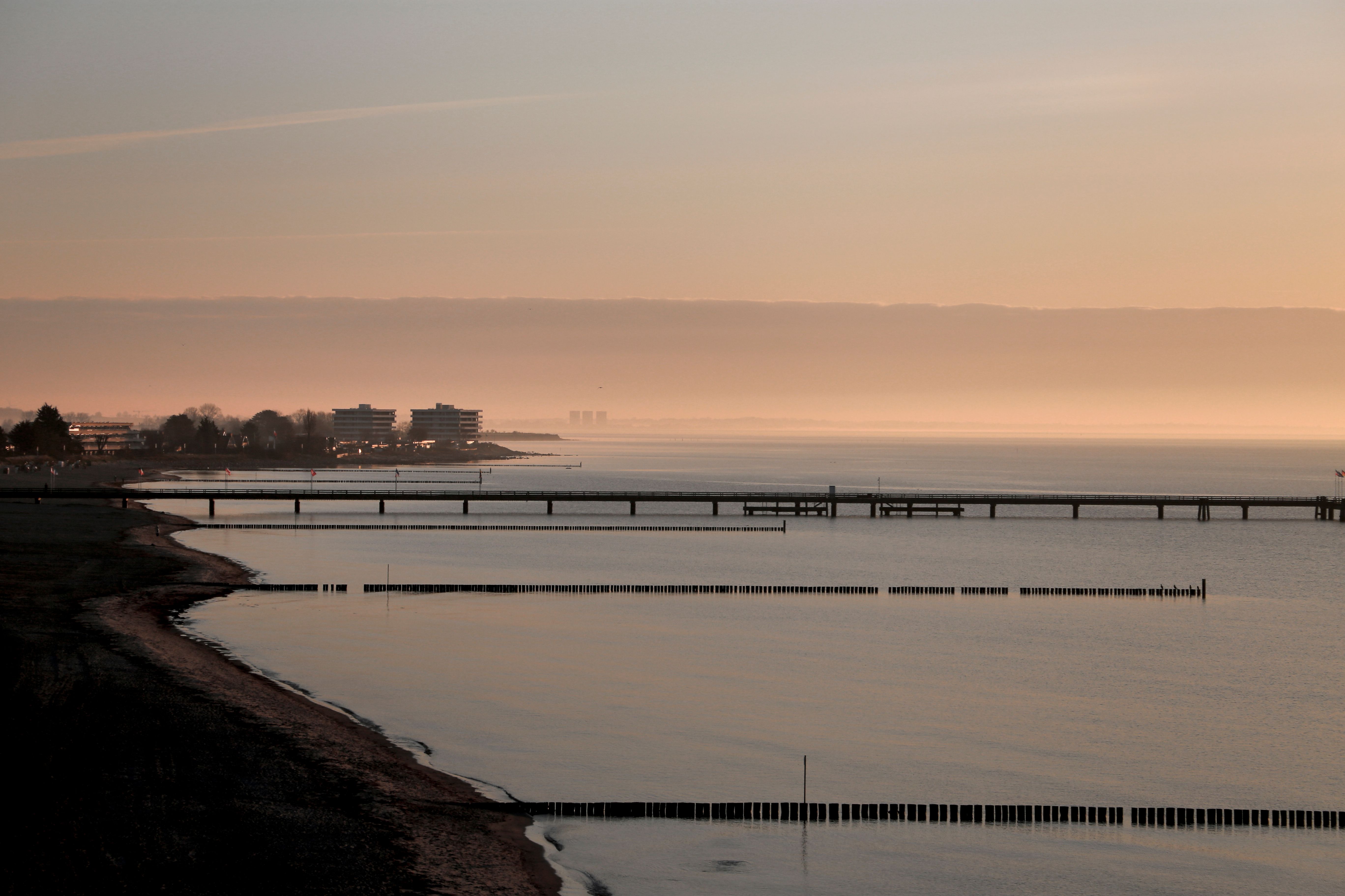 Tranquil Baltic Sea at Sunrise with Pier View · Free Stock Photo
