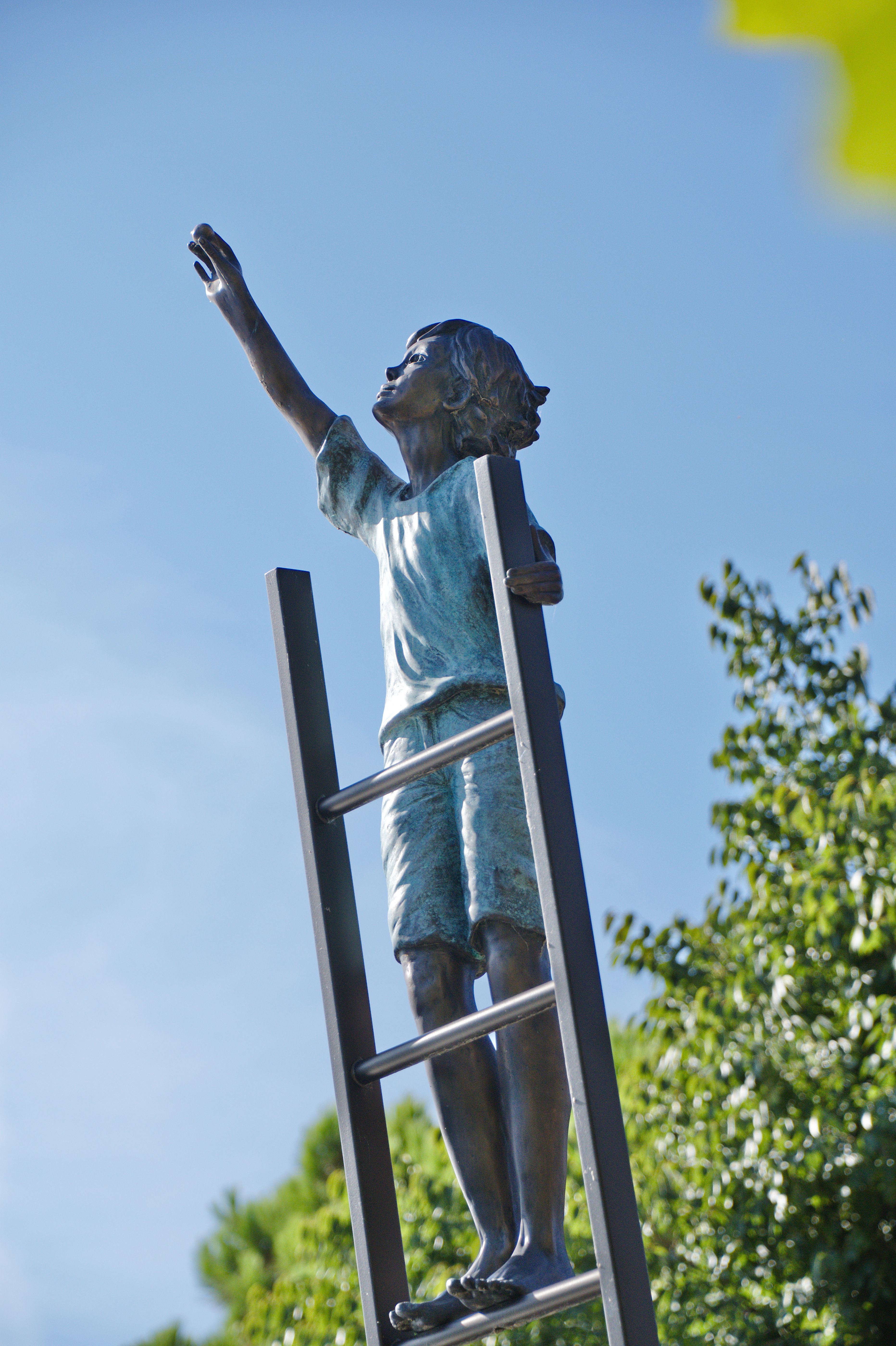 Statue of Child Climbing Ladder in Montreux · Free Stock Photo