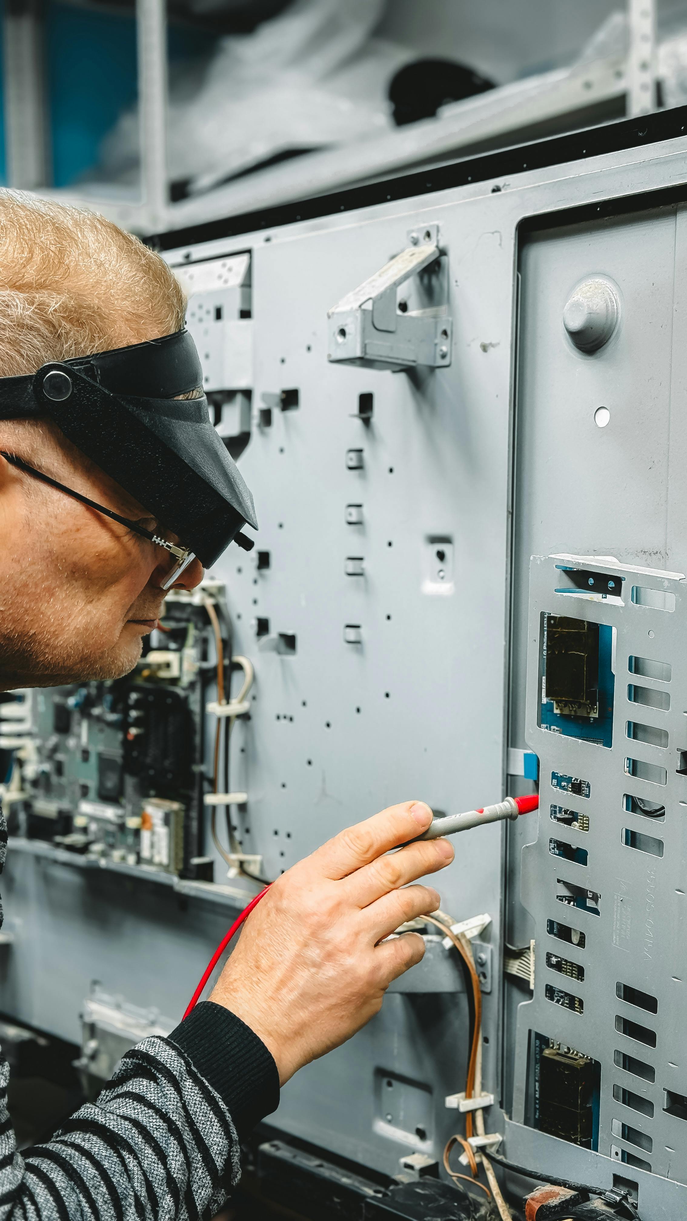 A man is working on an electrical panel · Free Stock Photo