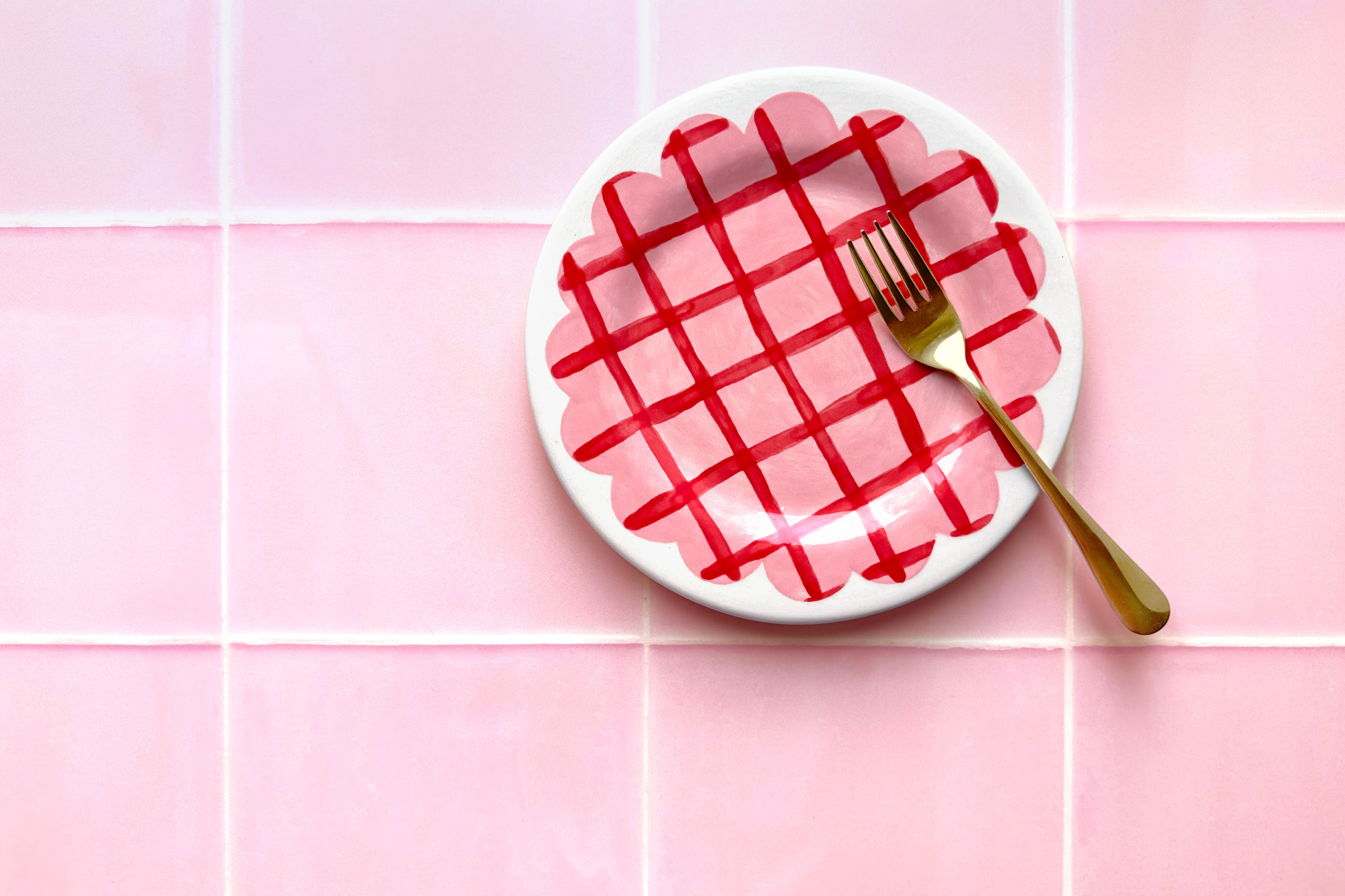 Pink Ceramic Plate on Tiled Surface · Free Stock Photo