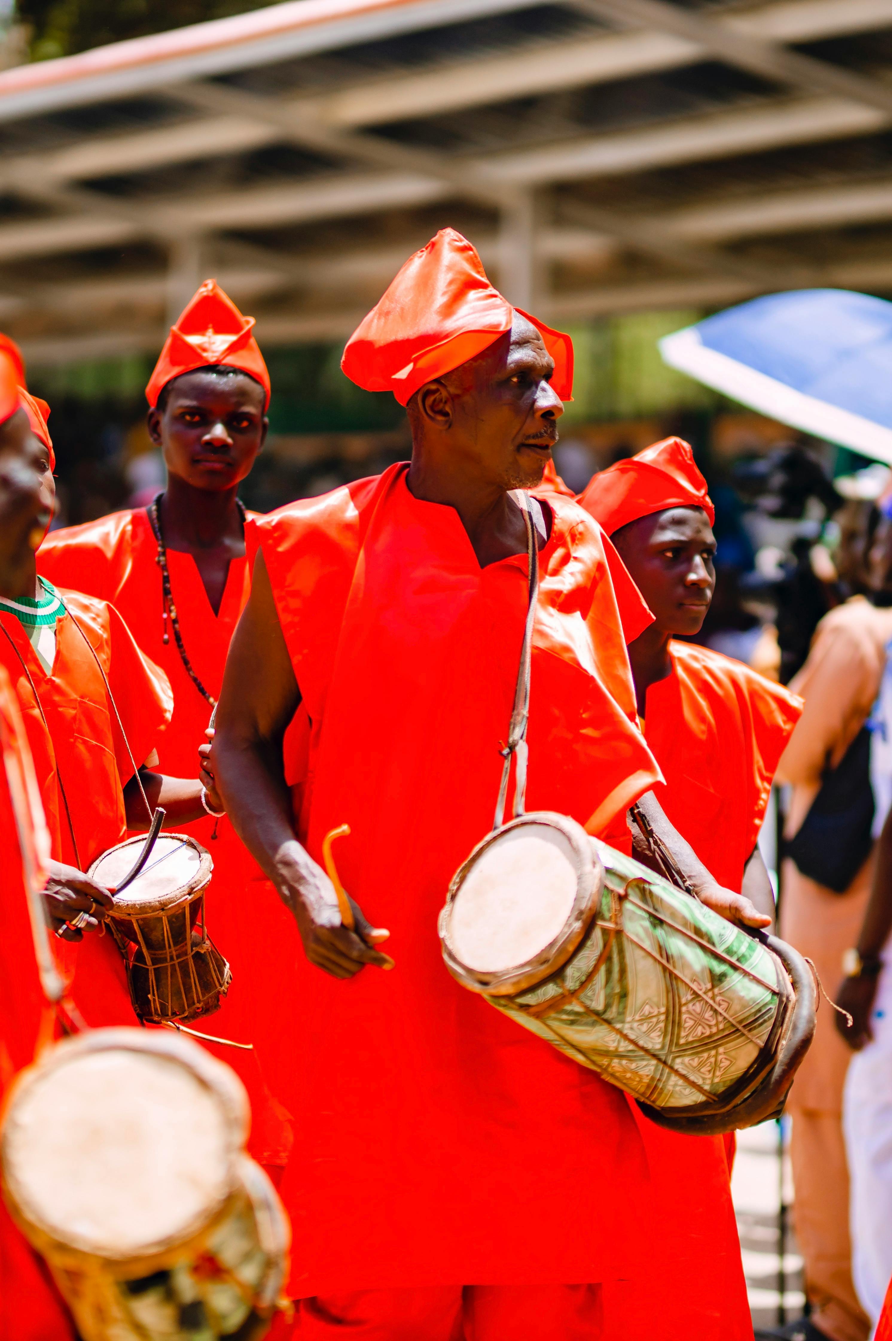 Traditional African Drummers in Vibrant Red Garb · Free Stock Photo