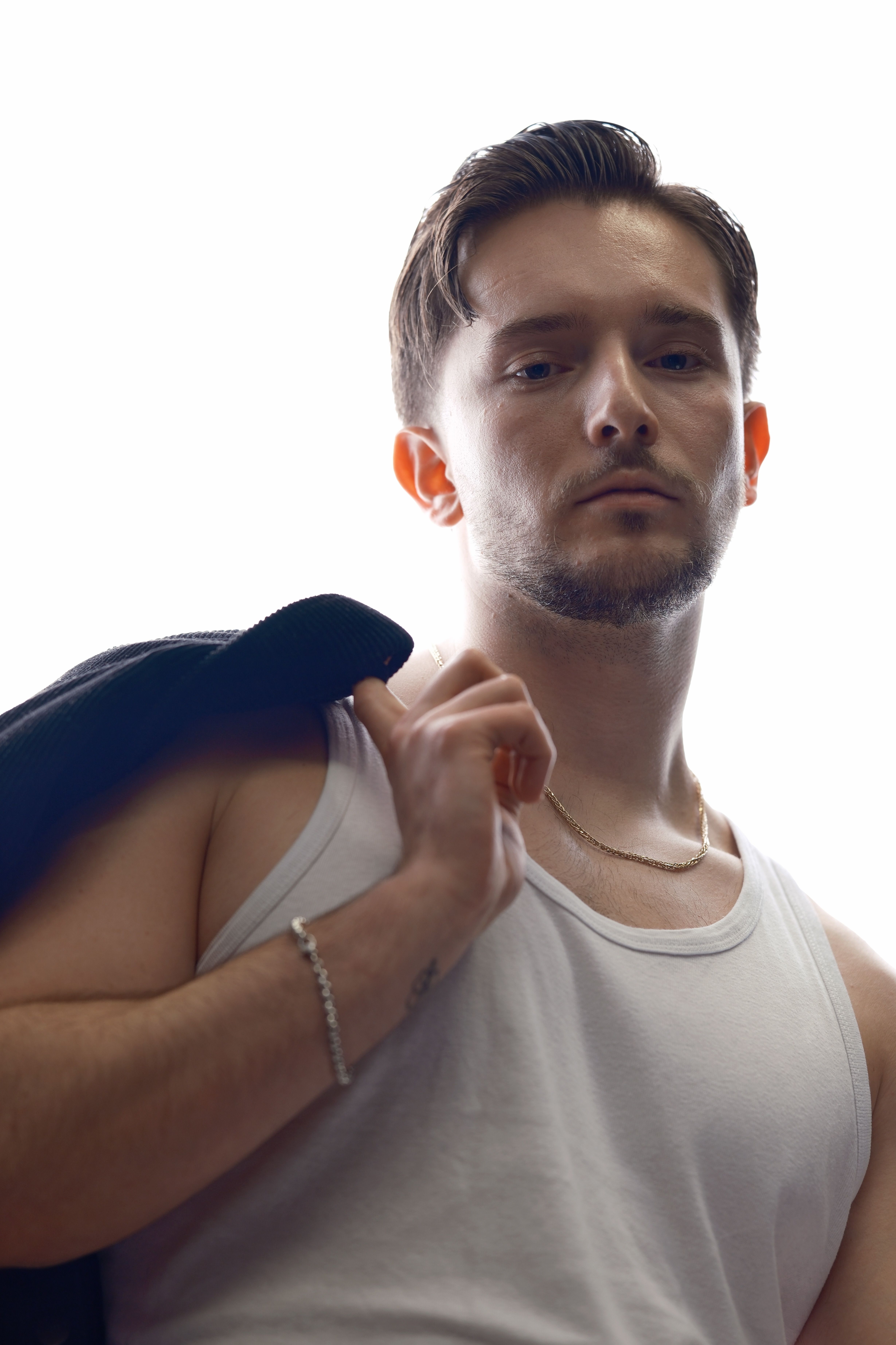 Confident Man Posing with Jacket Over Shoulder · Free Stock Photo