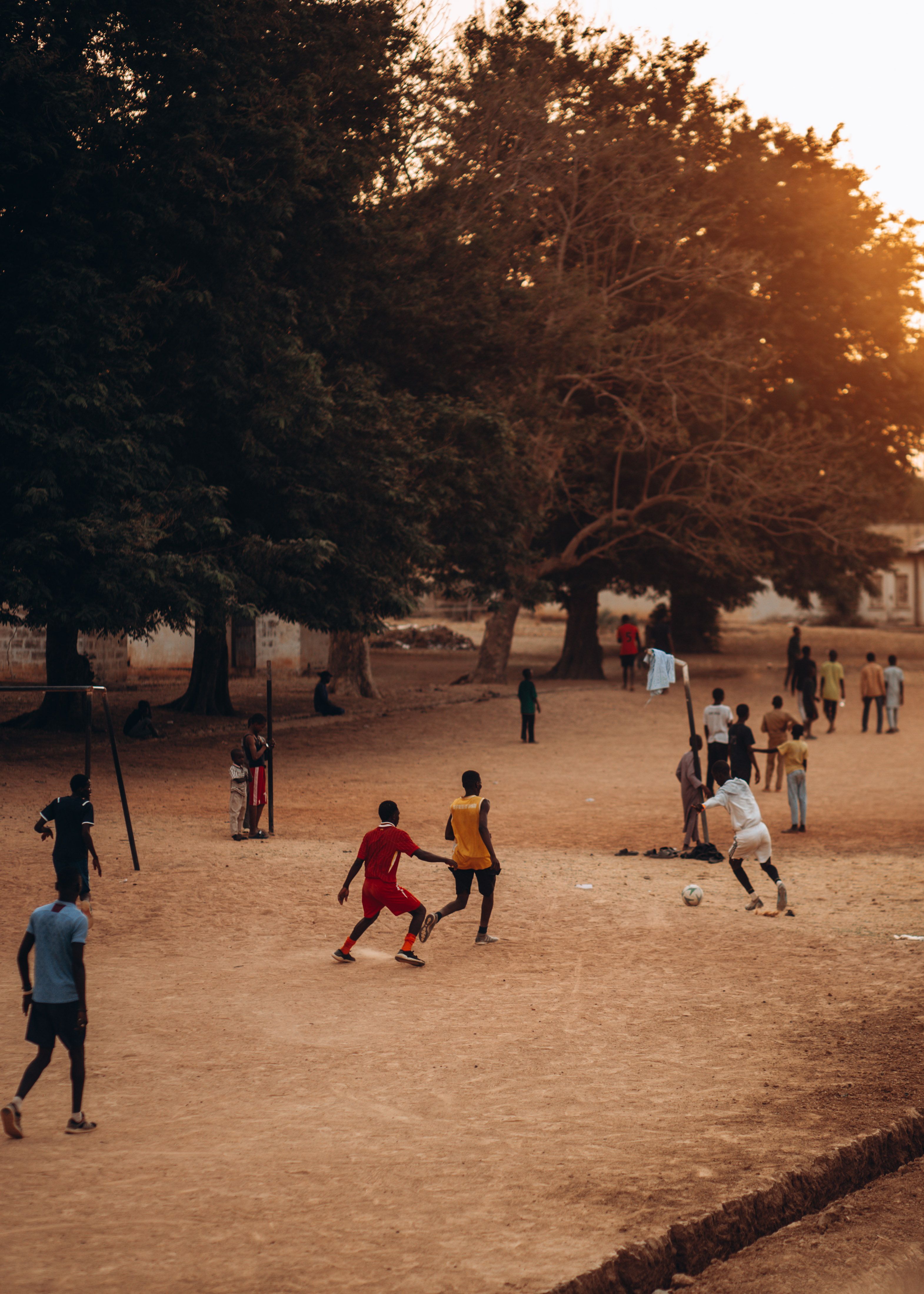 Children Playing Soccer in Rustic Outdoor Field · Free Stock Photo