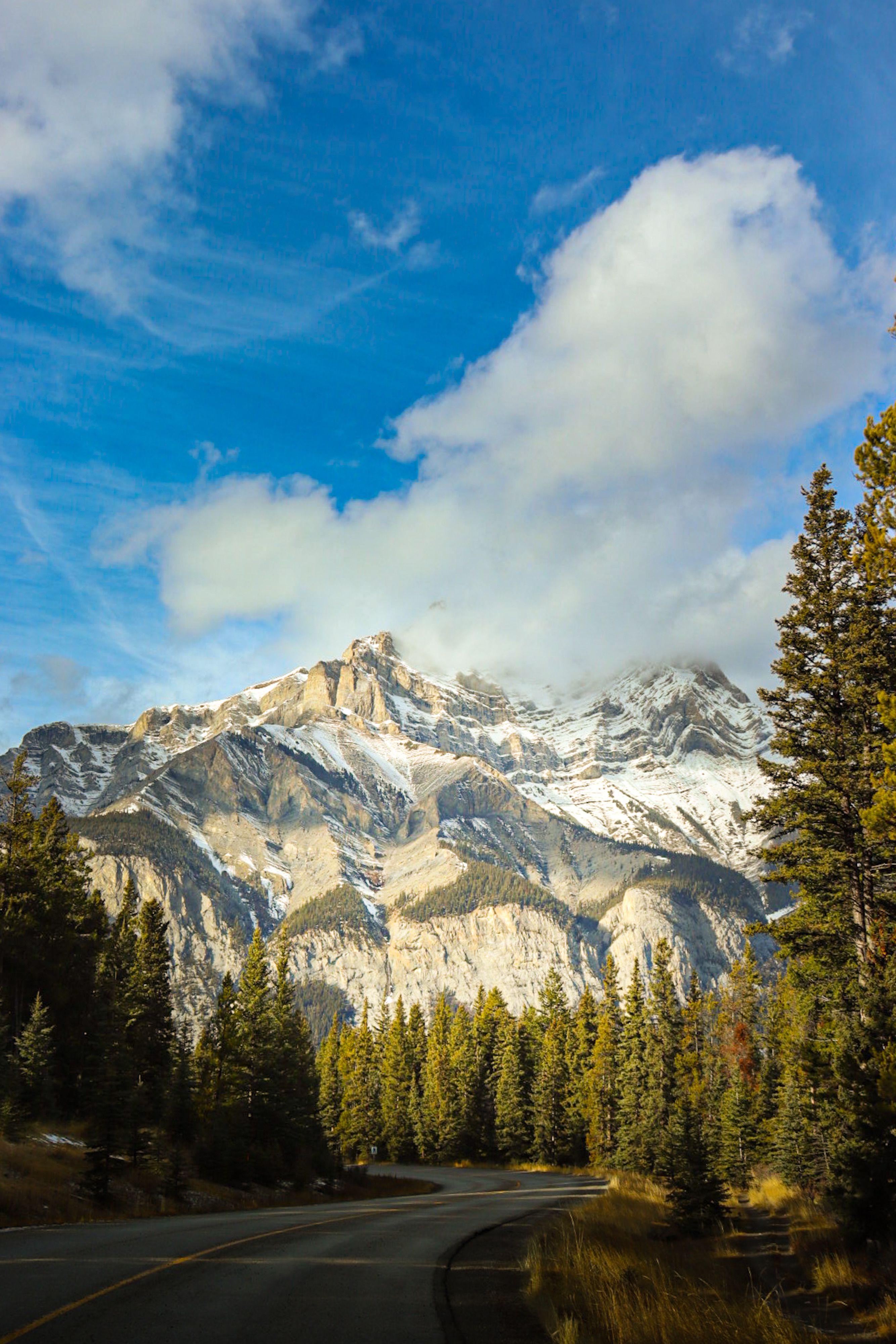 Scenic Mountain Road in Snow-Capped Rockies · Free Stock Photo