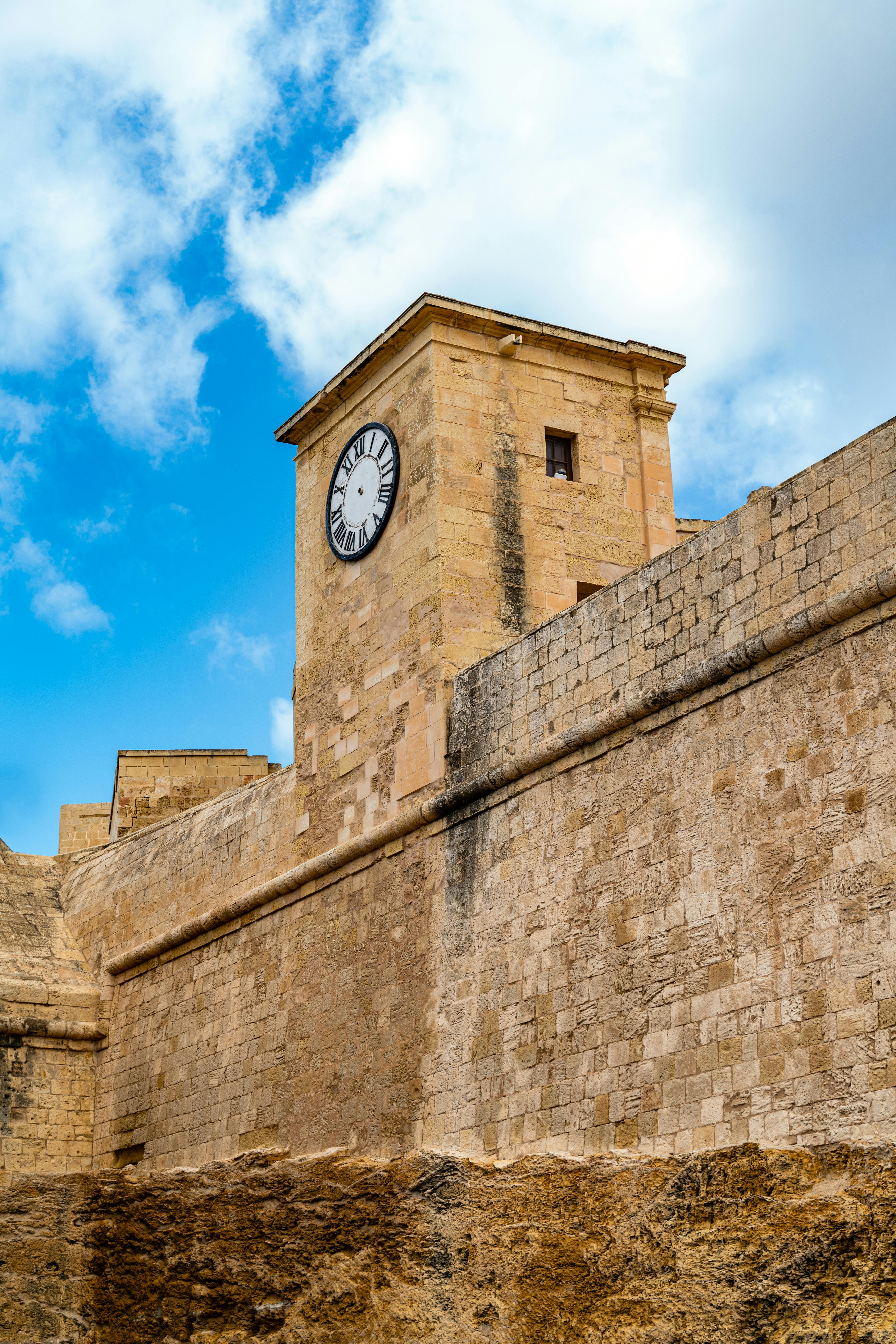 Historic Clock Tower in Malta Under Blue Sky · Free Stock Photo