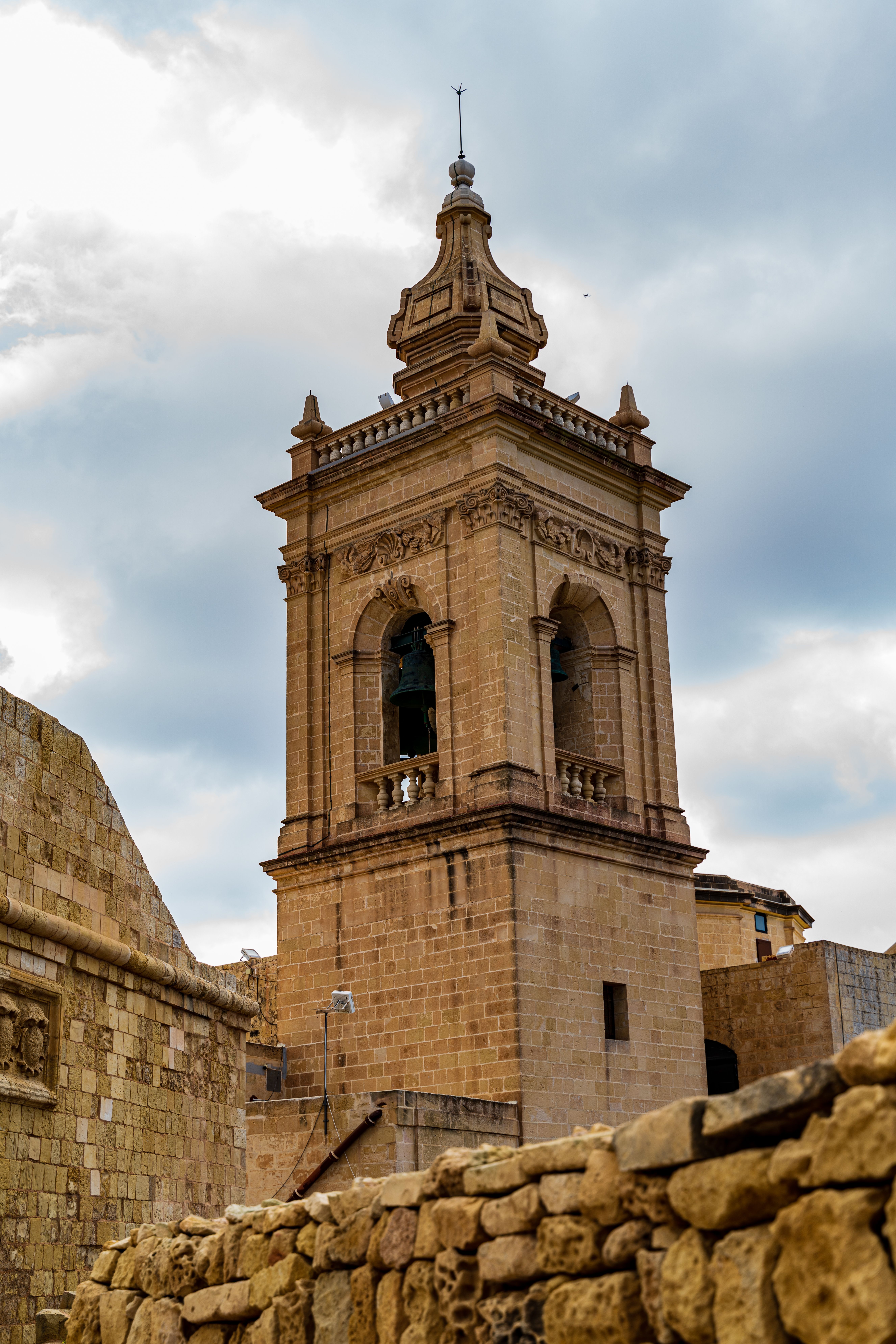 Historic Bell Tower in Malta Under Cloudy Skies · Free Stock Photo