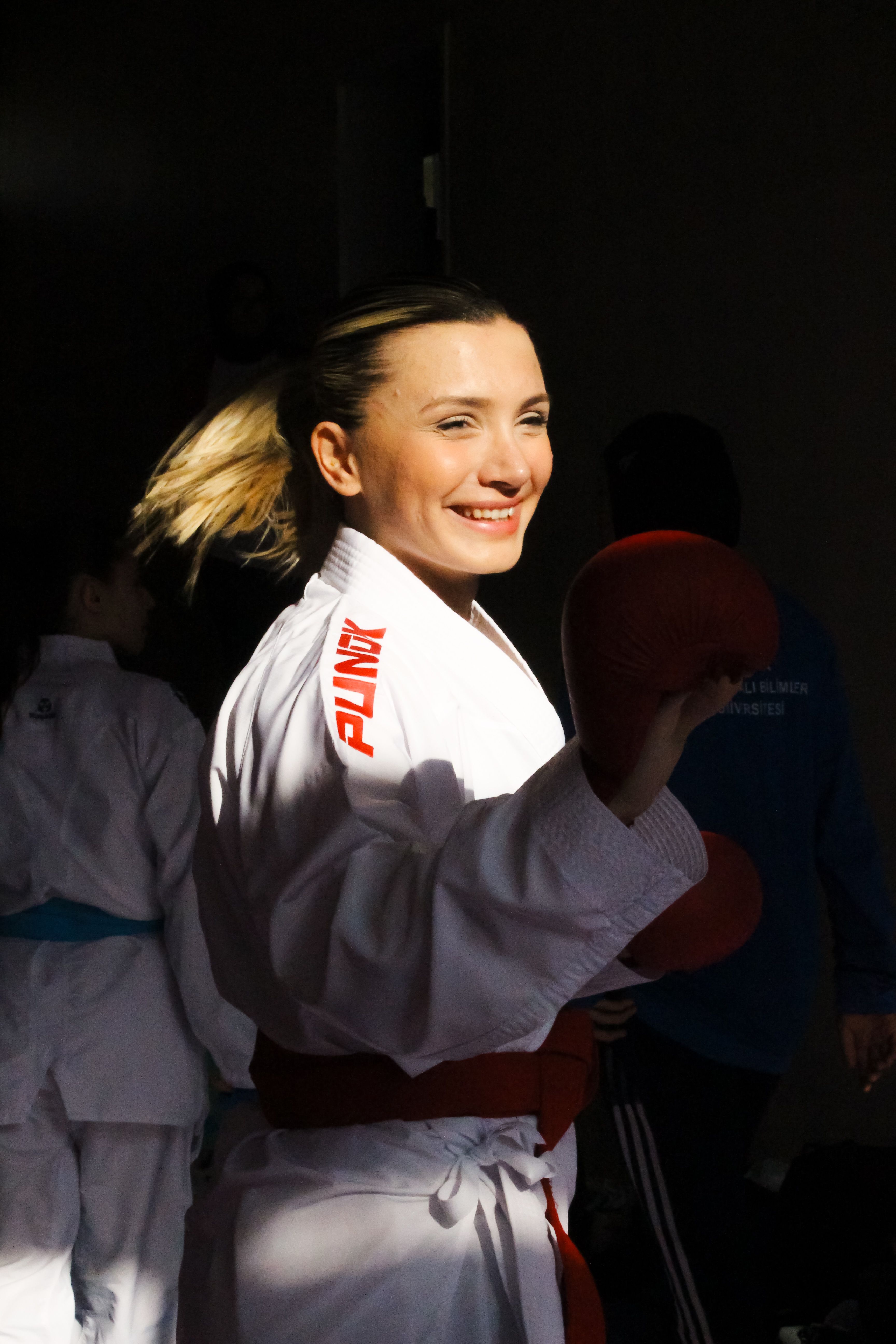Female Karate Competitor in Action Smiling · Free Stock Photo