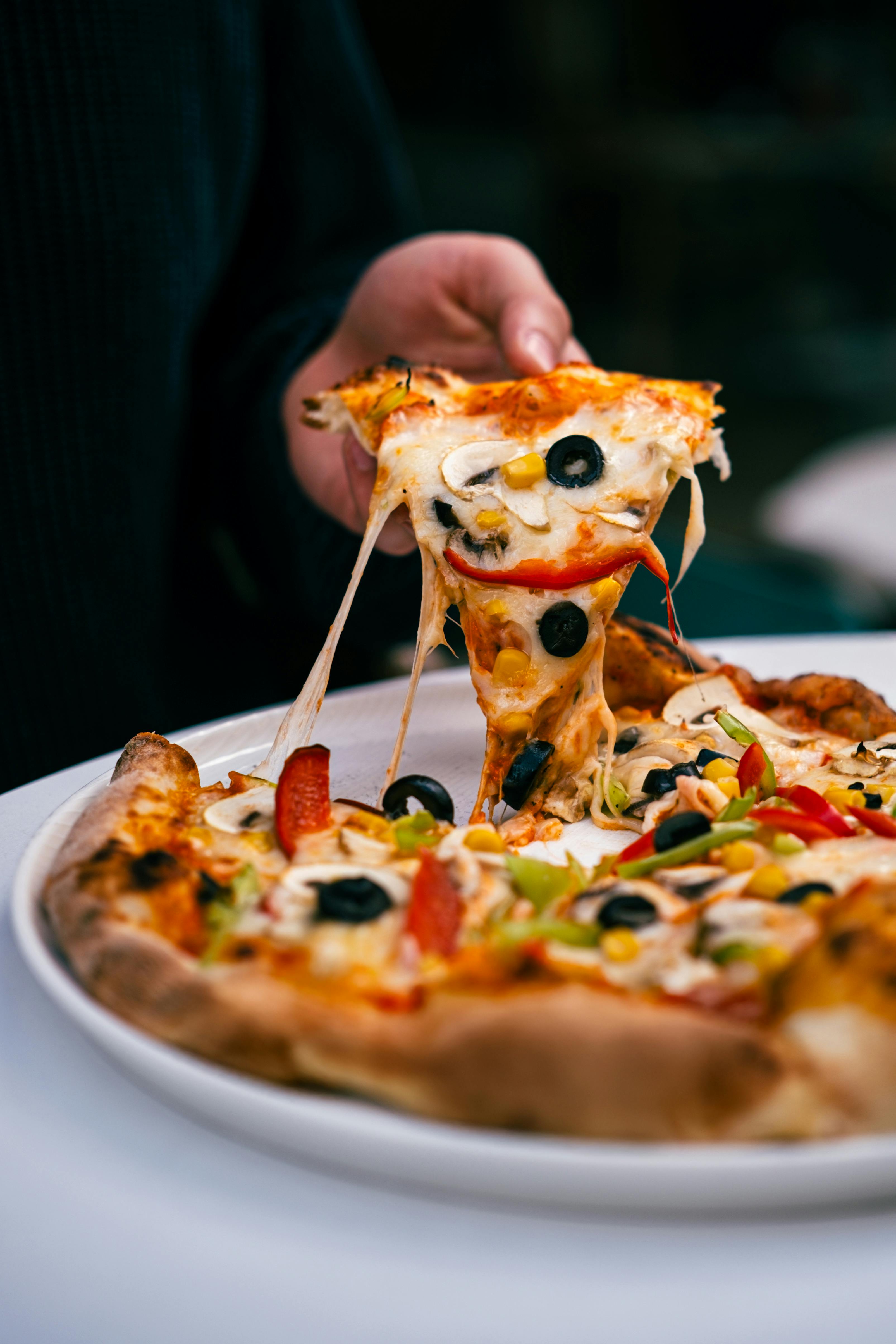 Close-up of Tasty Cheese Pizza Slice Being Served · Free Stock Photo