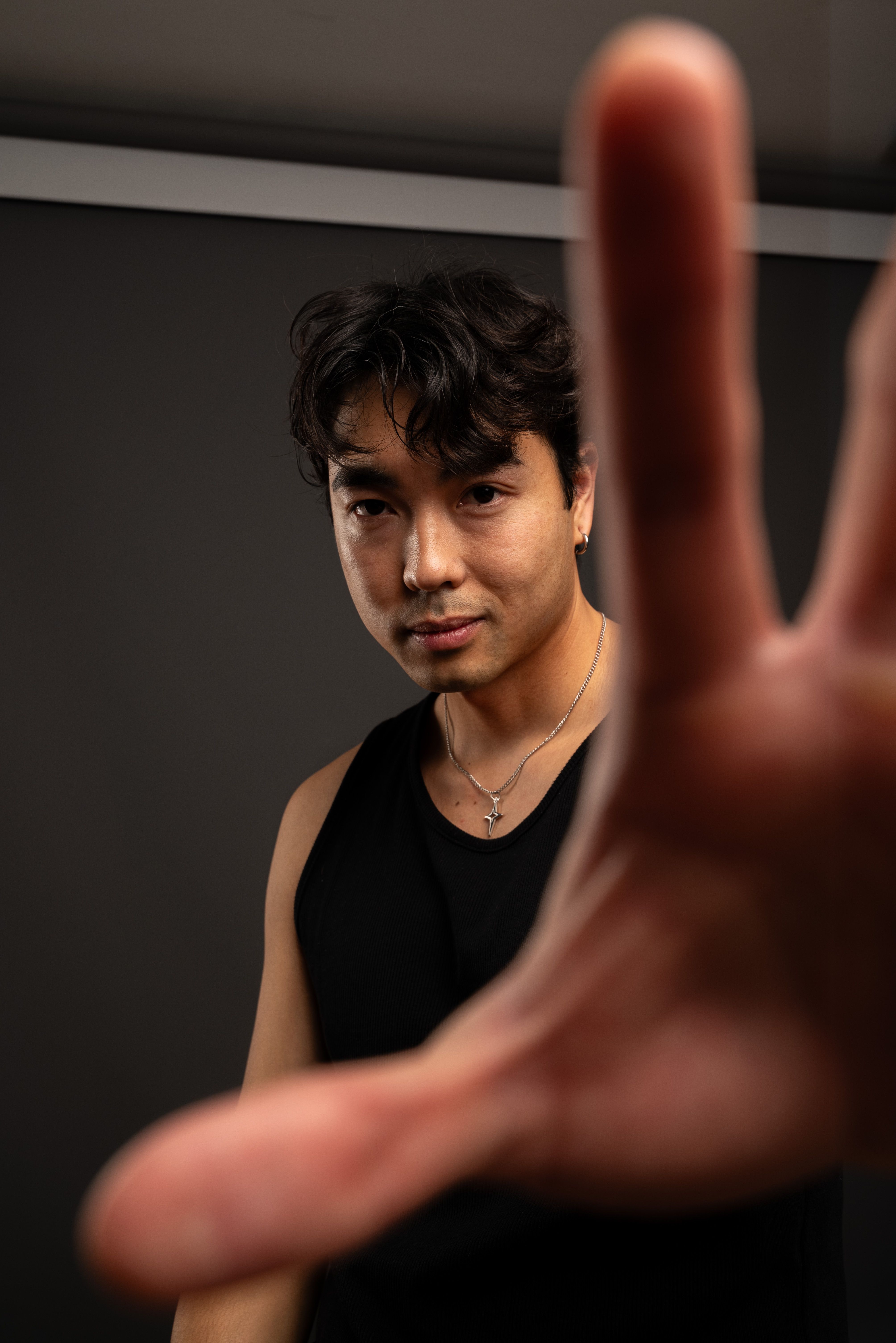 Portrait of a Young Man Posing with Hand Gesture · Free Stock Photo