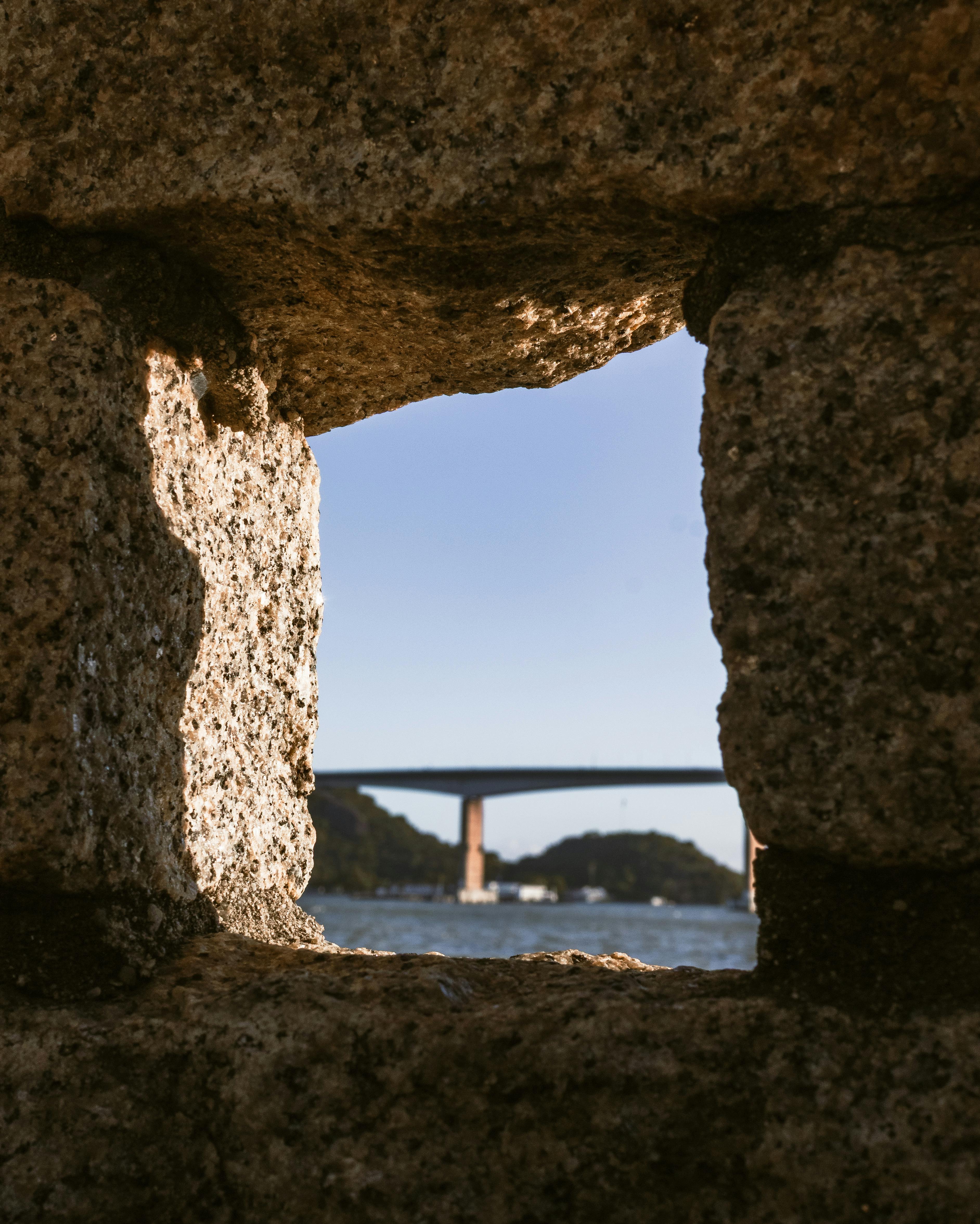 View of Bridge Through Stone Wall Opening · Free Stock Photo