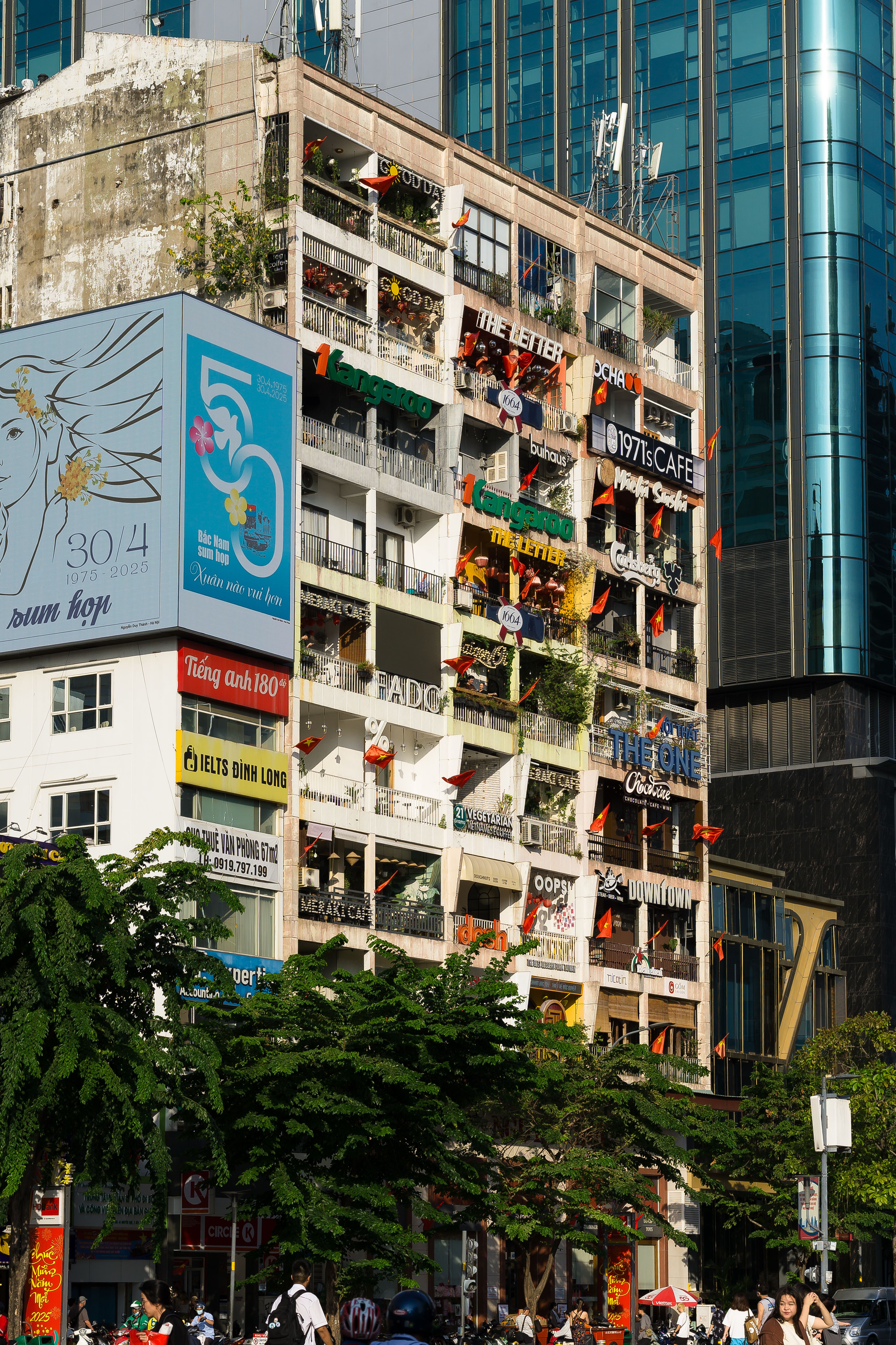 Vibrant facade of Saigon's cafe apartment building · Free Stock Photo