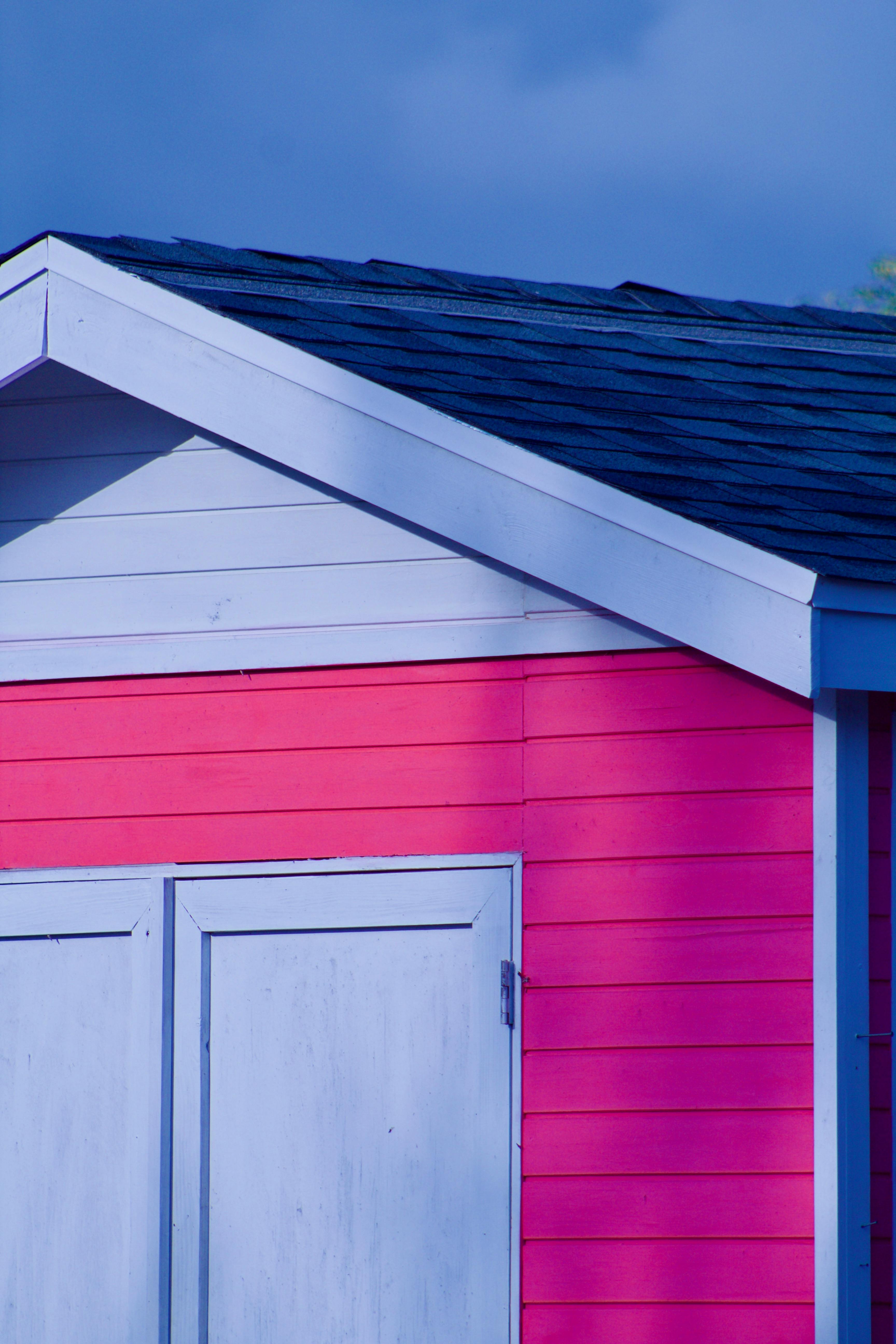 Vibrant Pink Shed under Blue Sky · Free Stock Photo