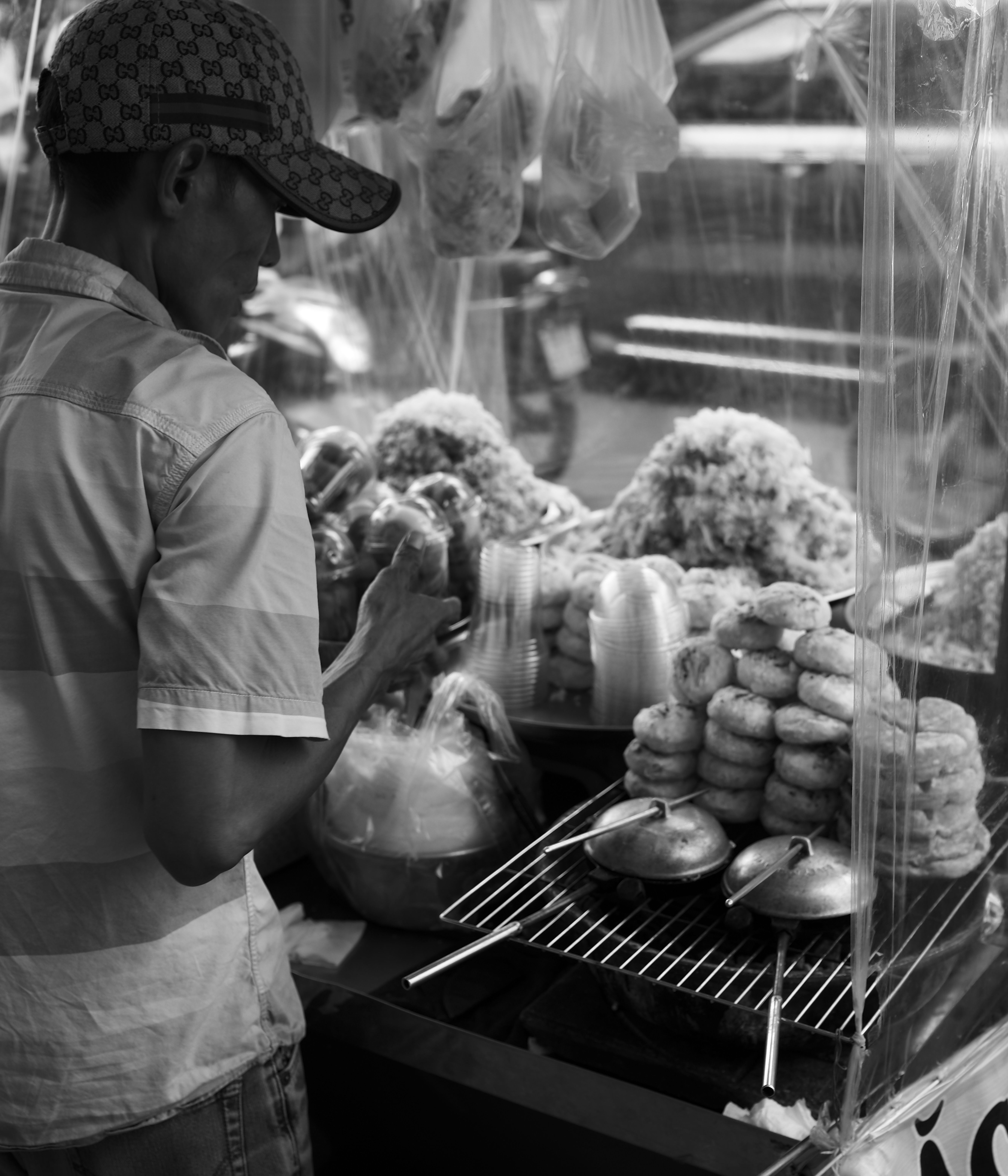 Street Vendor at Food Stall Selling Snacks · Free Stock Photo
