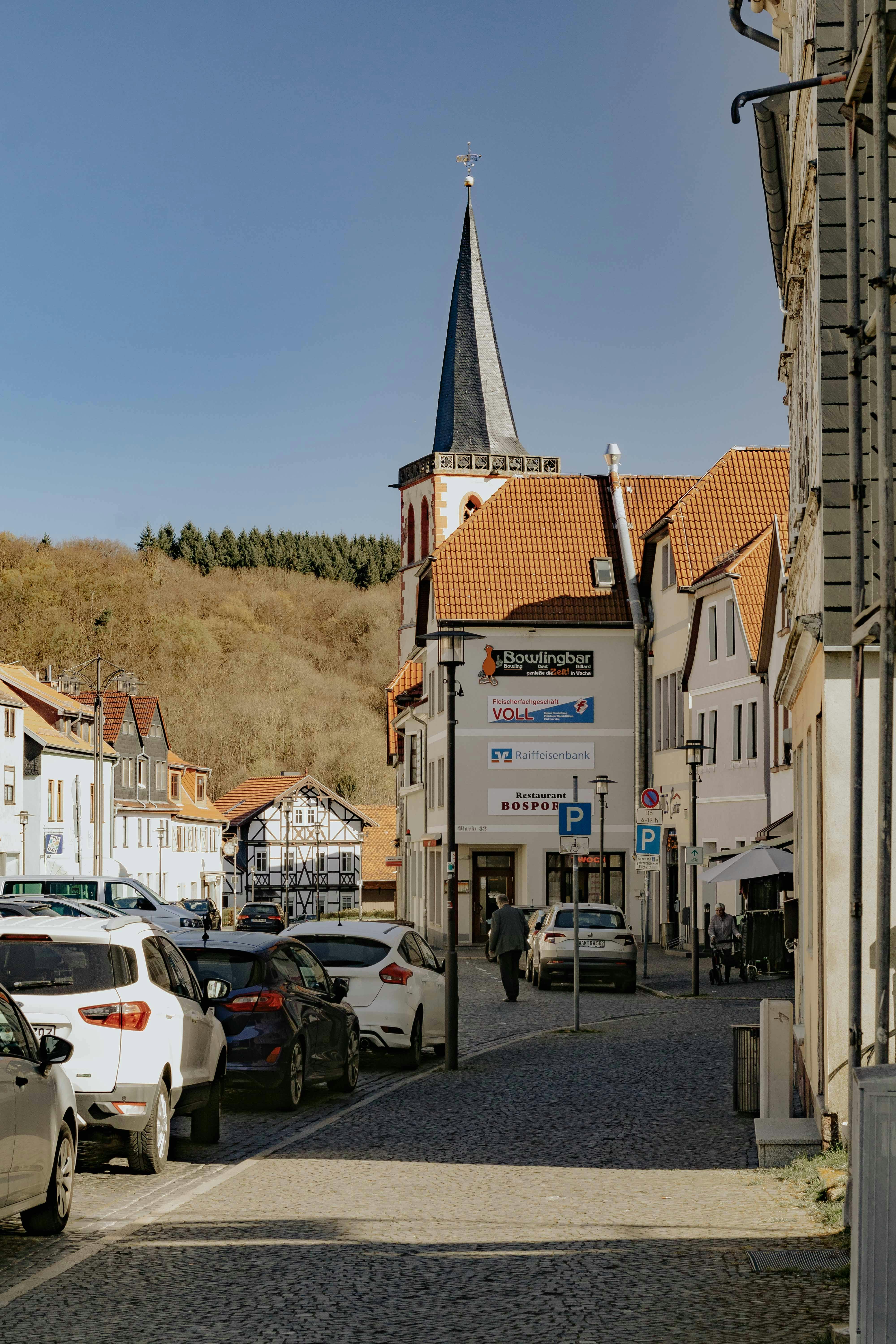 Quaint European Street with Tower Building · Free Stock Photo