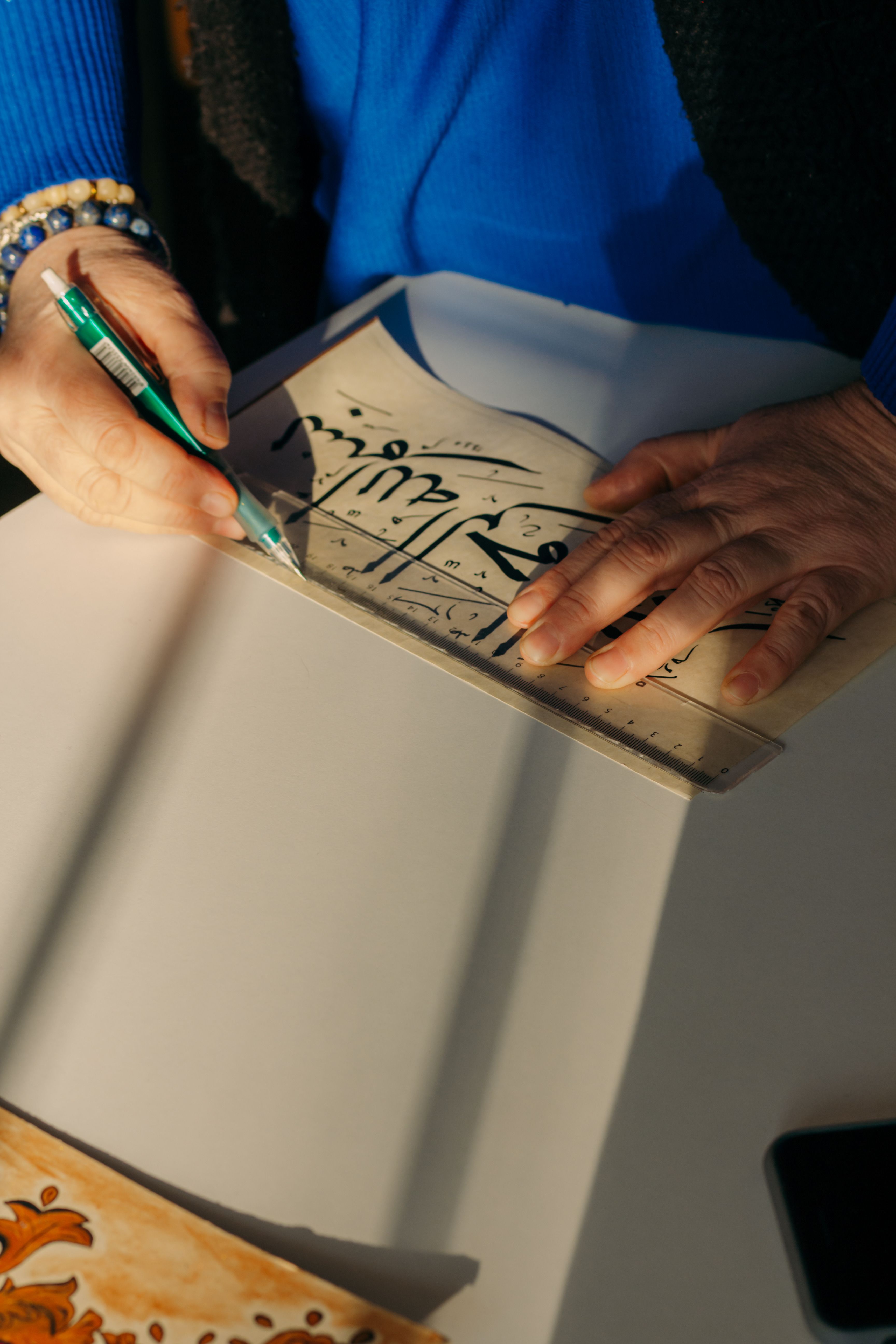 Person Practicing Calligraphy with Pen and Ruler · Free Stock Photo