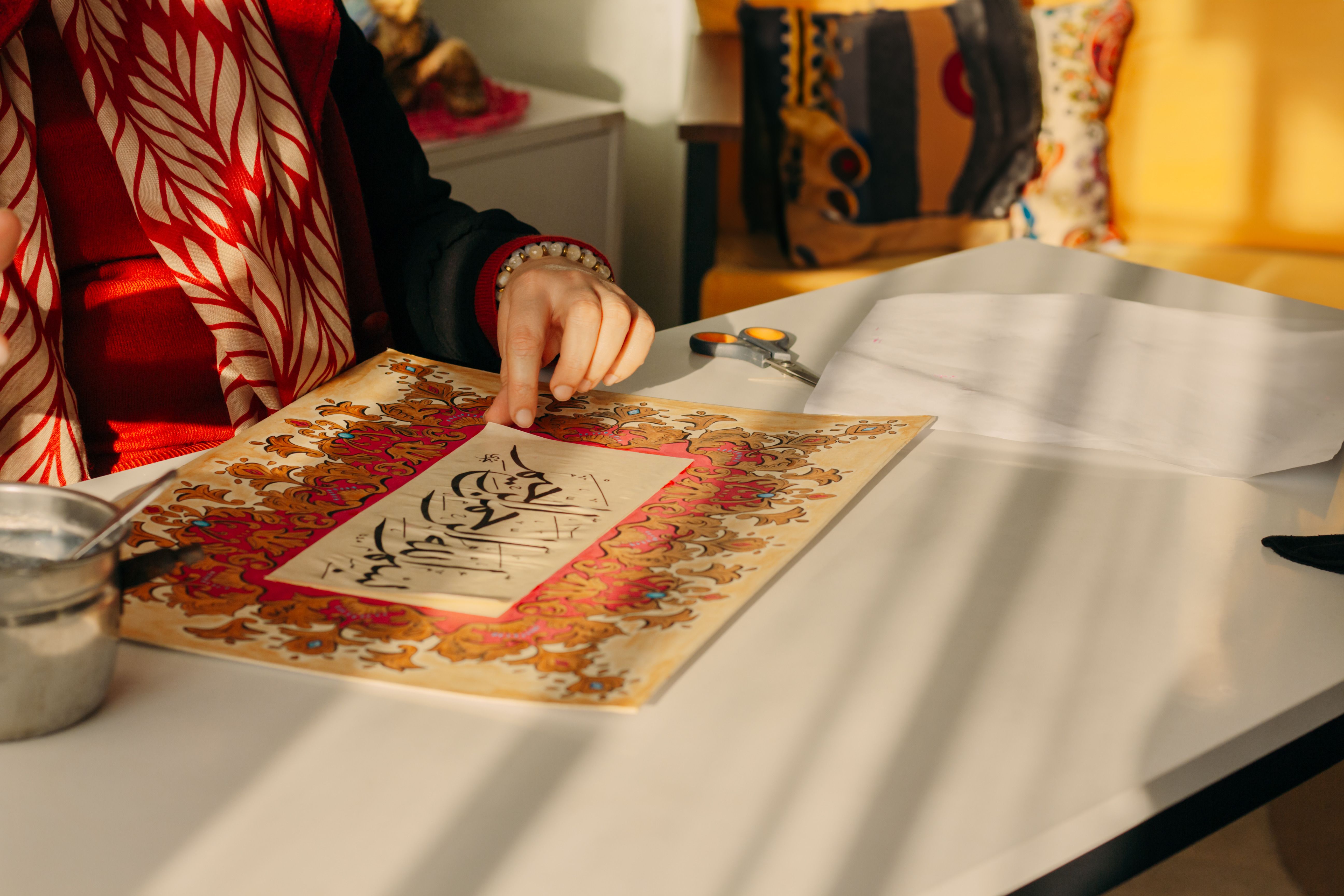 Woman Pointing at Ornate Arabic Calligraphy · Free Stock Photo