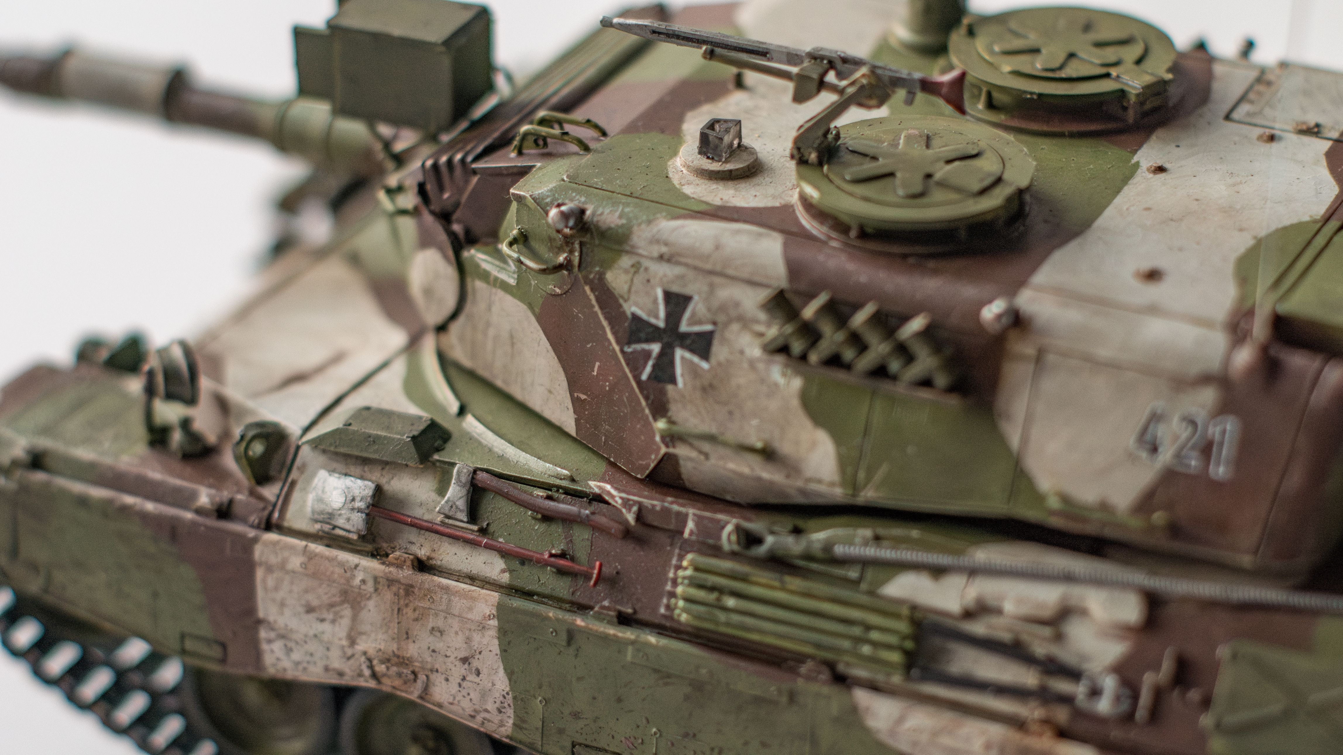 Detailed Close-up of a Camouflage Military Tank Model · Free Stock Photo