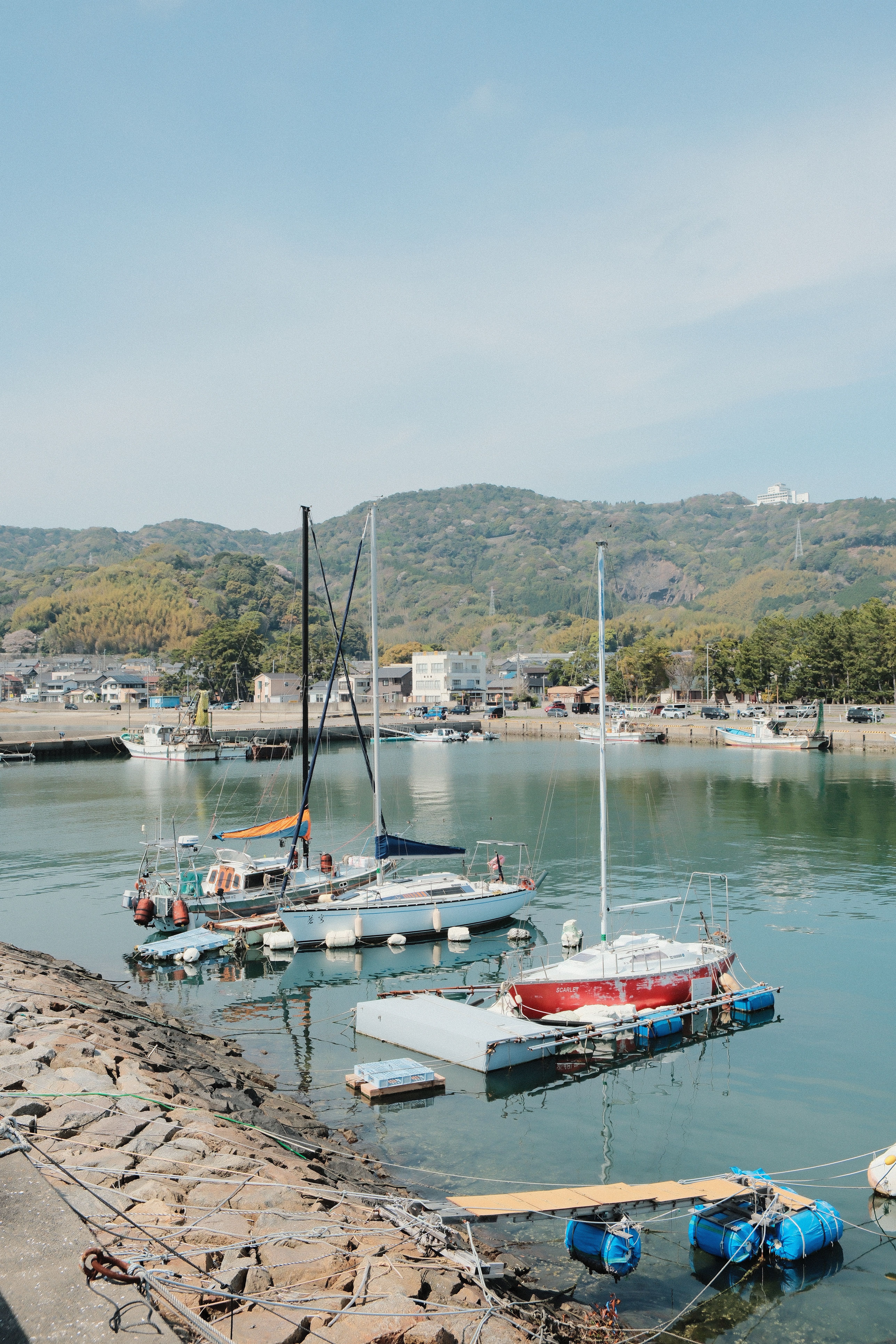 Tranquil Harbor Scene with Sailboats and Hills · Free Stock Photo