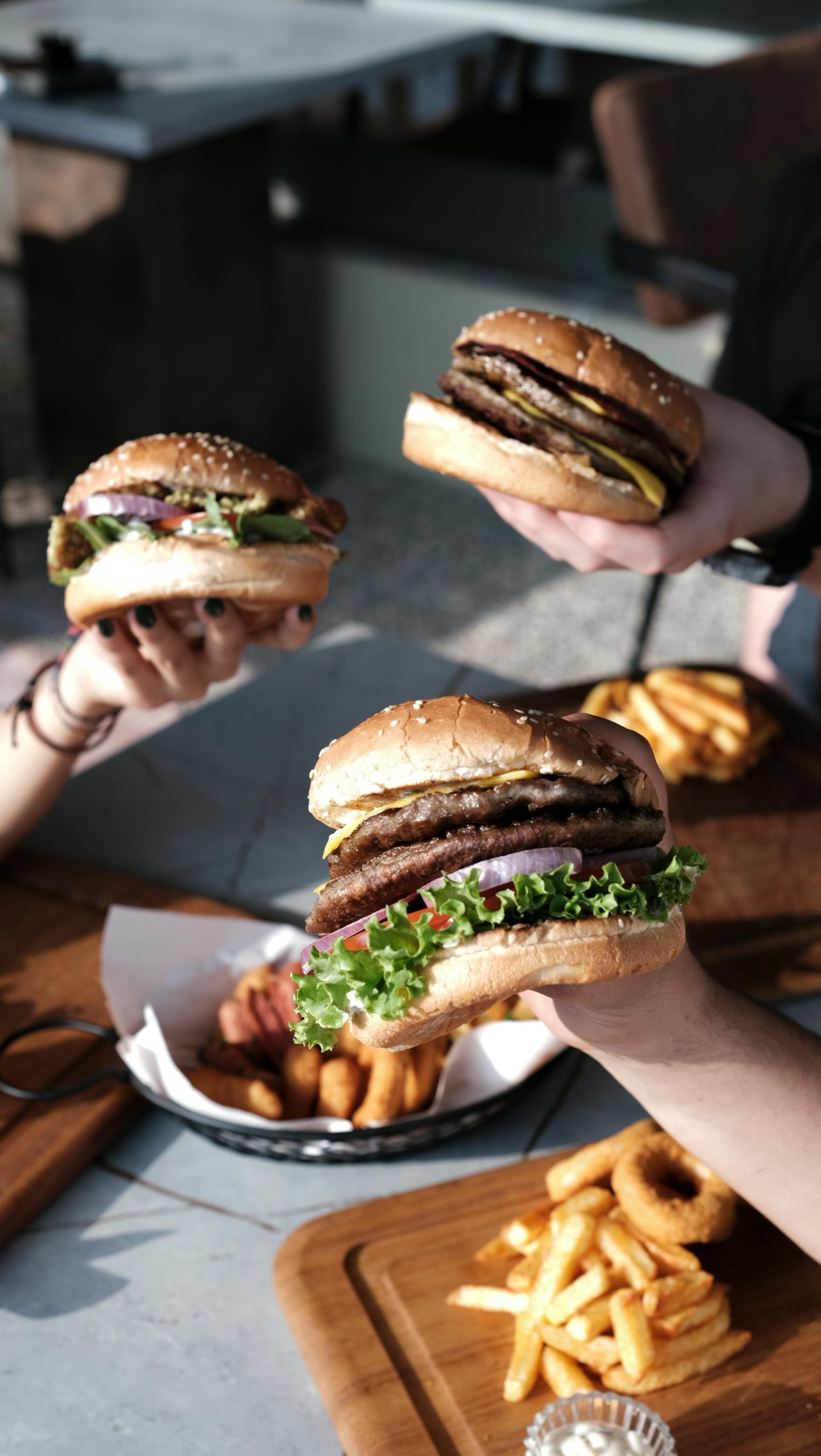 Delicious Fast Food Burgers and Fries Outdoors · Free Stock Photo