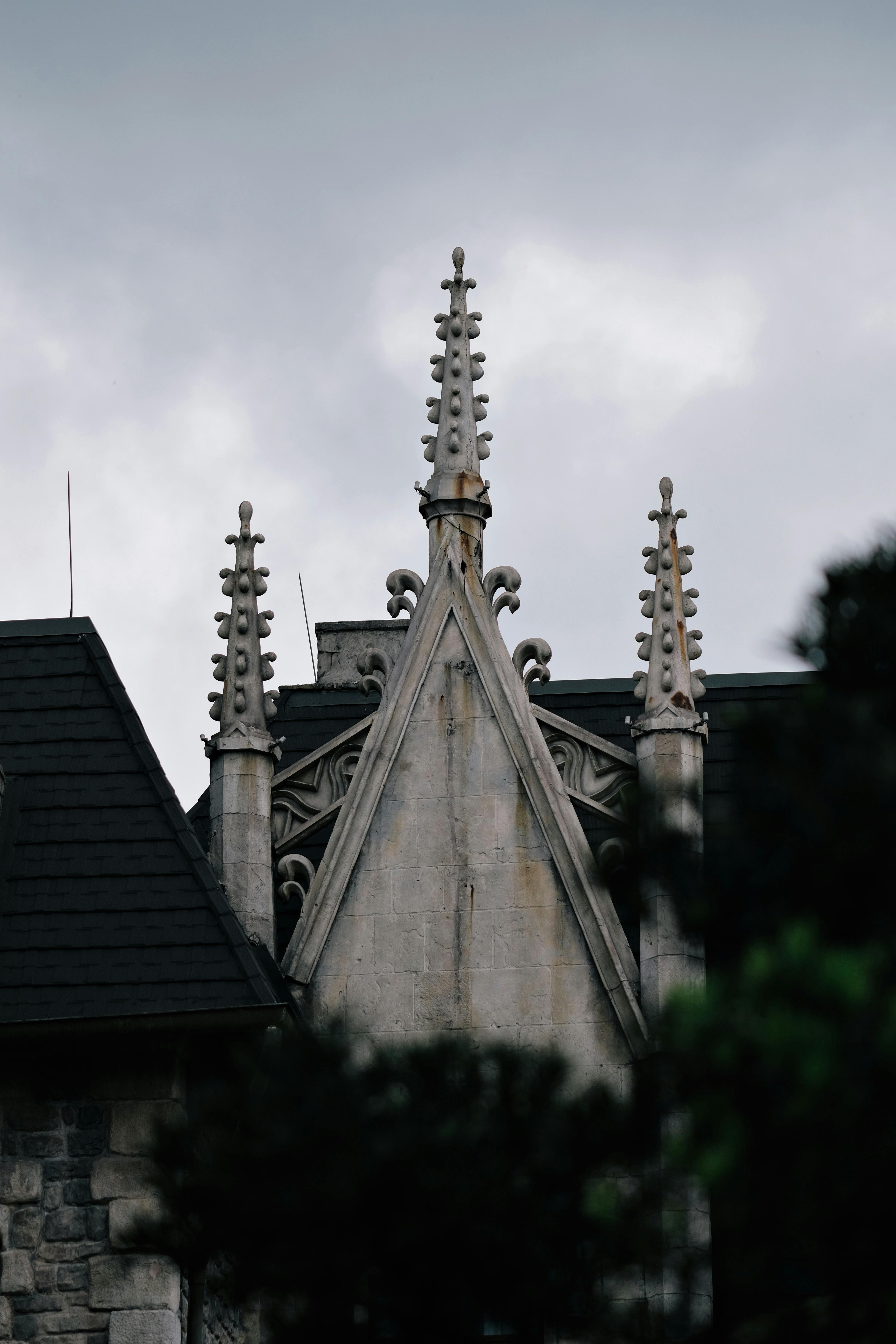Gothic Architectural Spires Against Cloudy Sky · Free Stock Photo