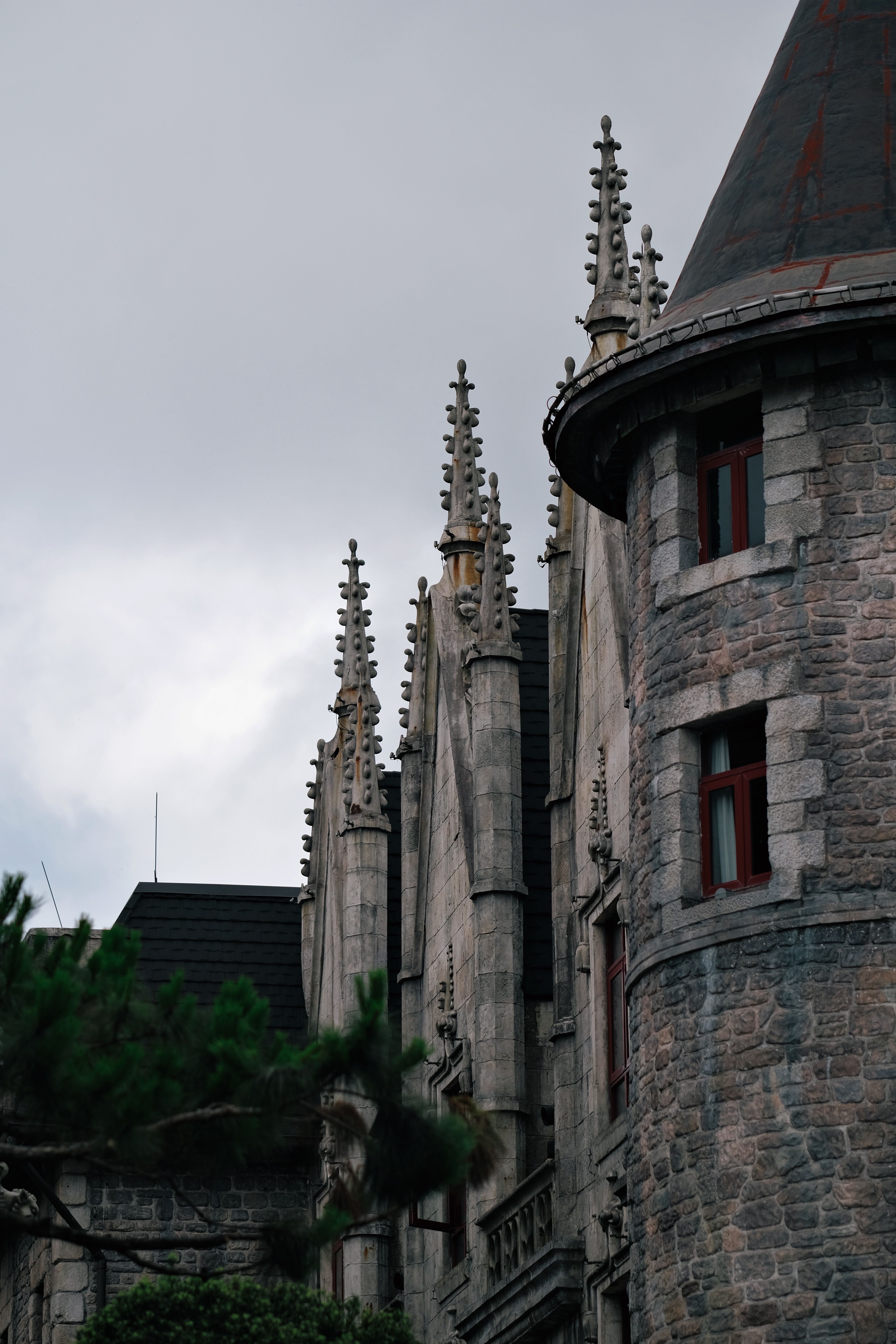 Gothic Castle with Ornate Spires Against Cloudy Sky · Free Stock Photo