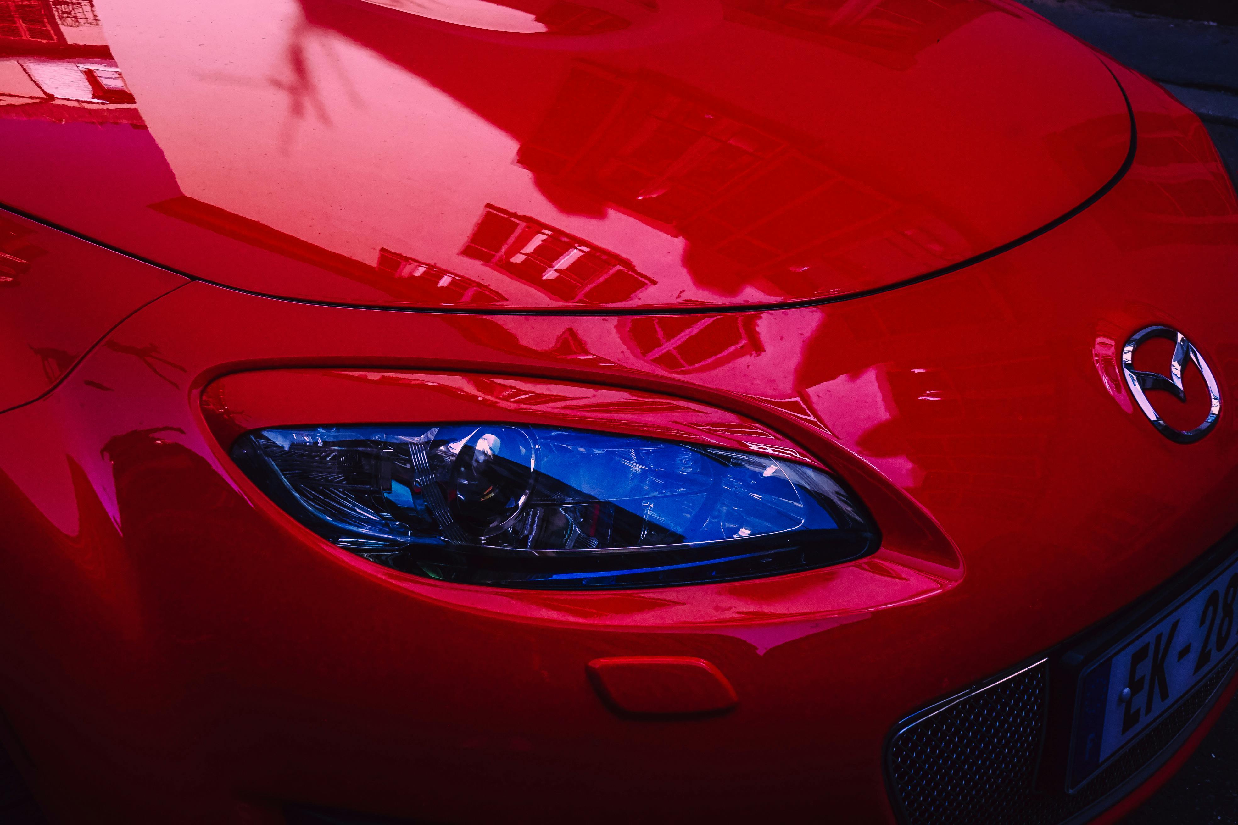 Vibrant Red Car Reflecting Strasbourg Architecture · Free Stock Photo