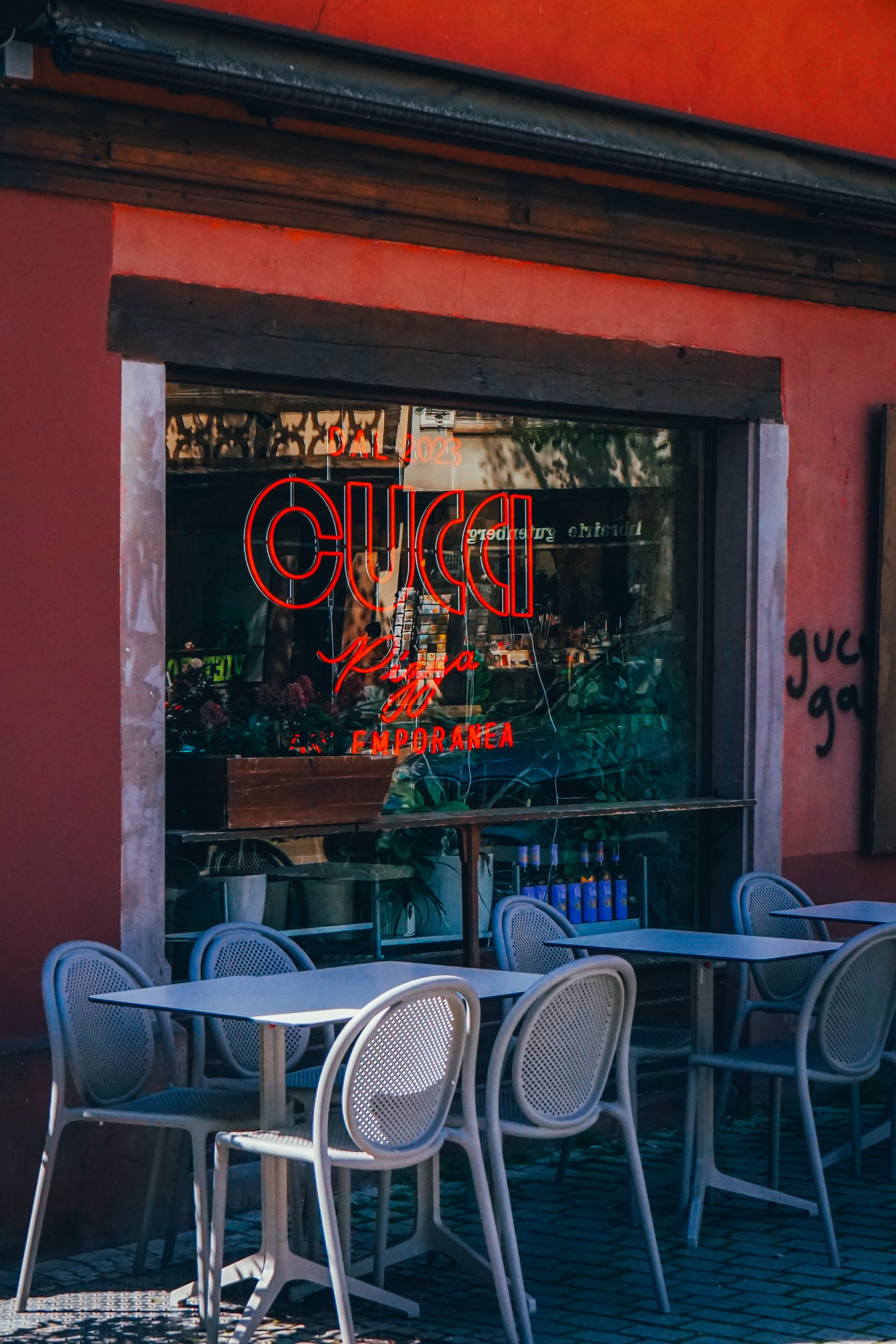 Outdoor Cafe with Red Neon Sign in Daylight · Free Stock Photo