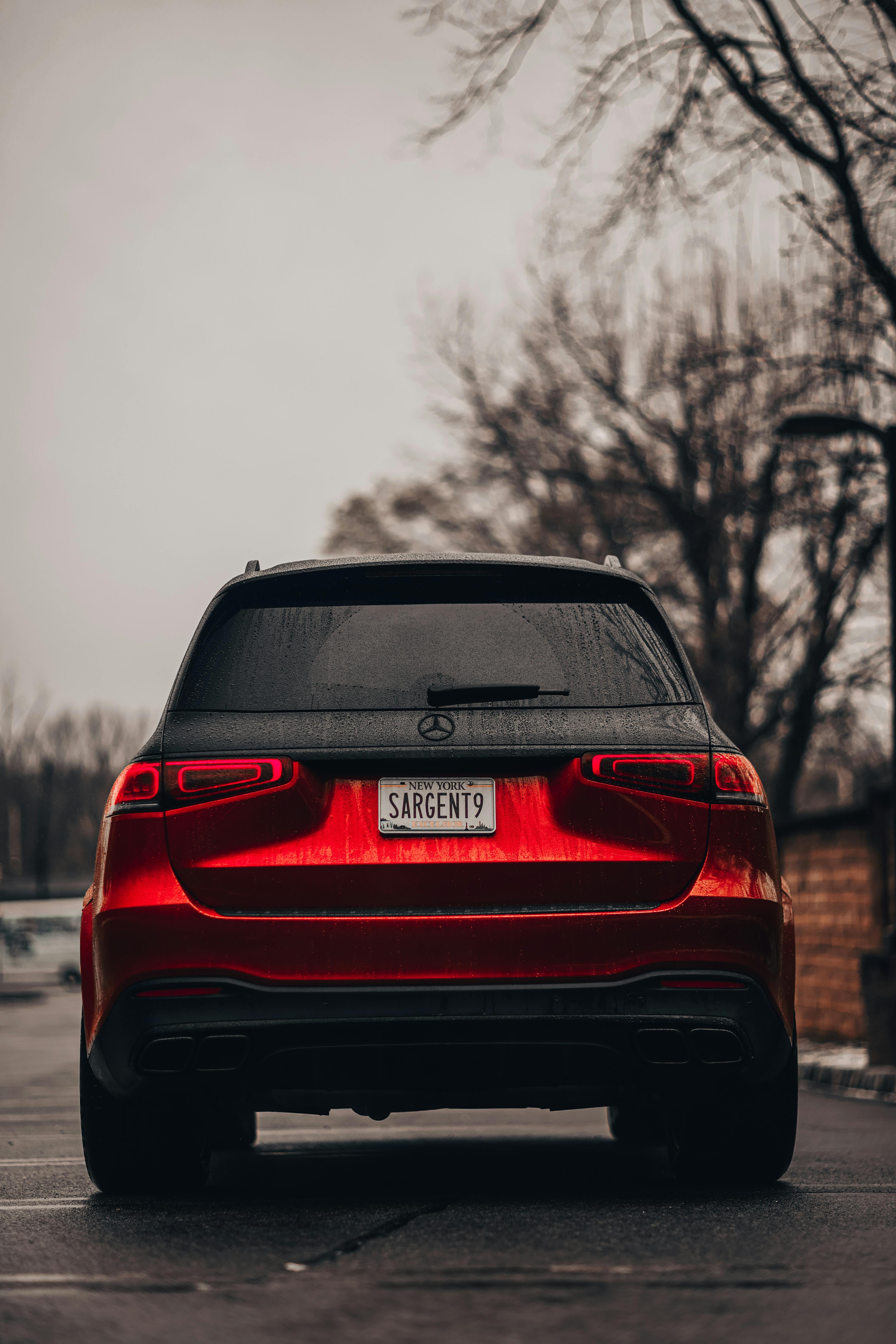 Red SUV on a Gloomy Road · Free Stock Photo