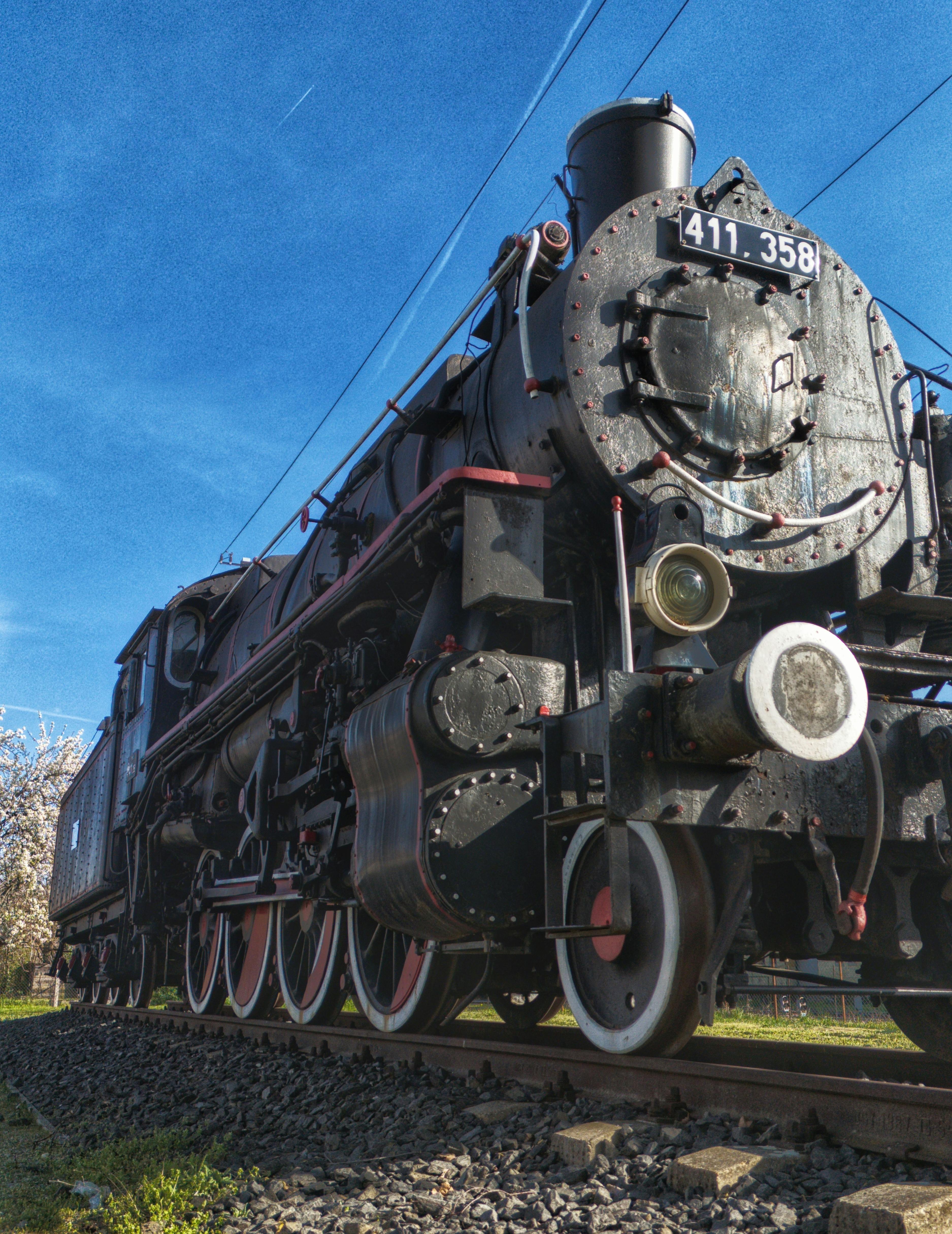 Steam Locomotive on Railway Track Under Blue Sky · Free Stock Photo