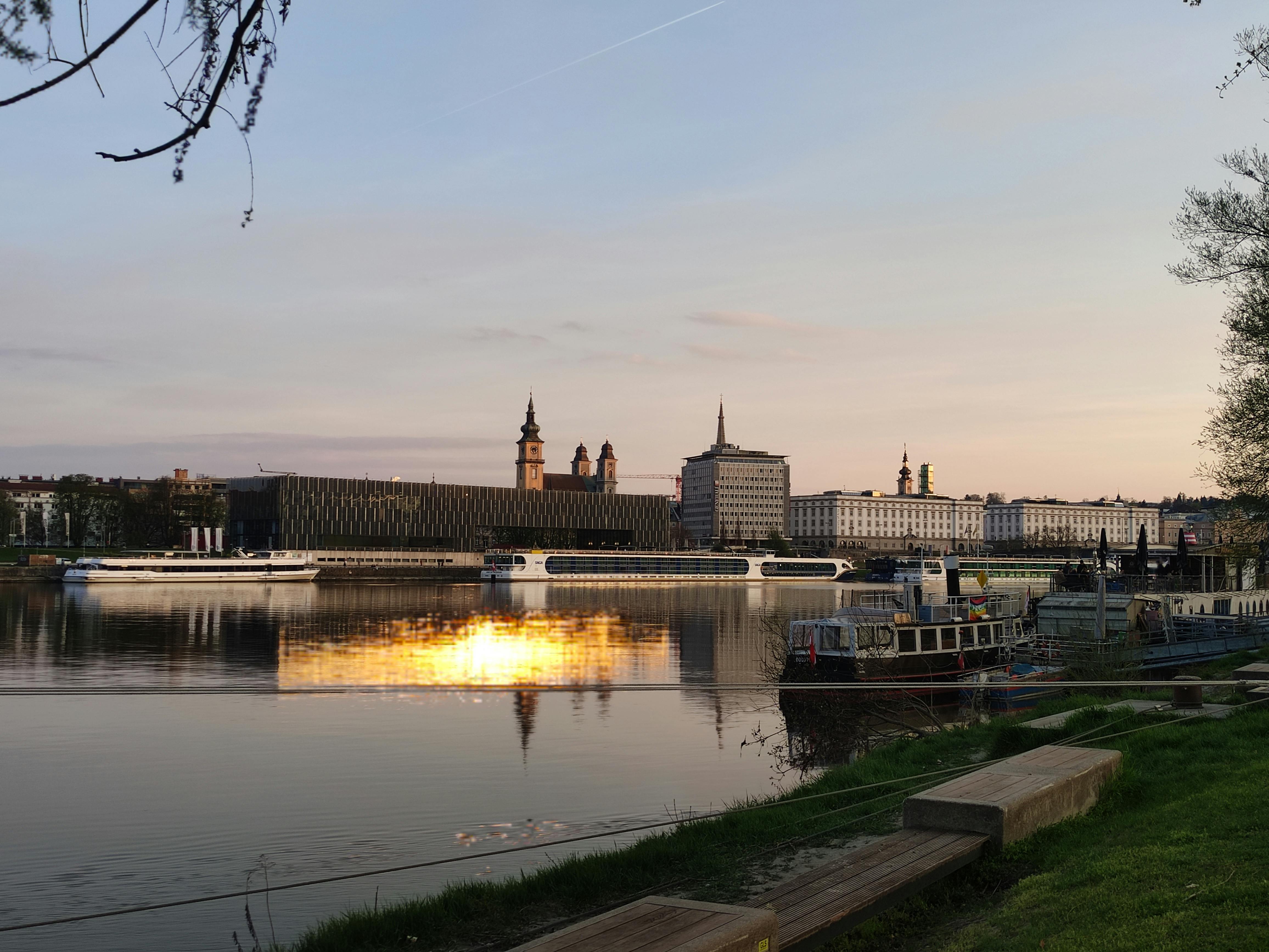 Sunset View of Linz Riverside with Historic Buildings · Free Stock Photo