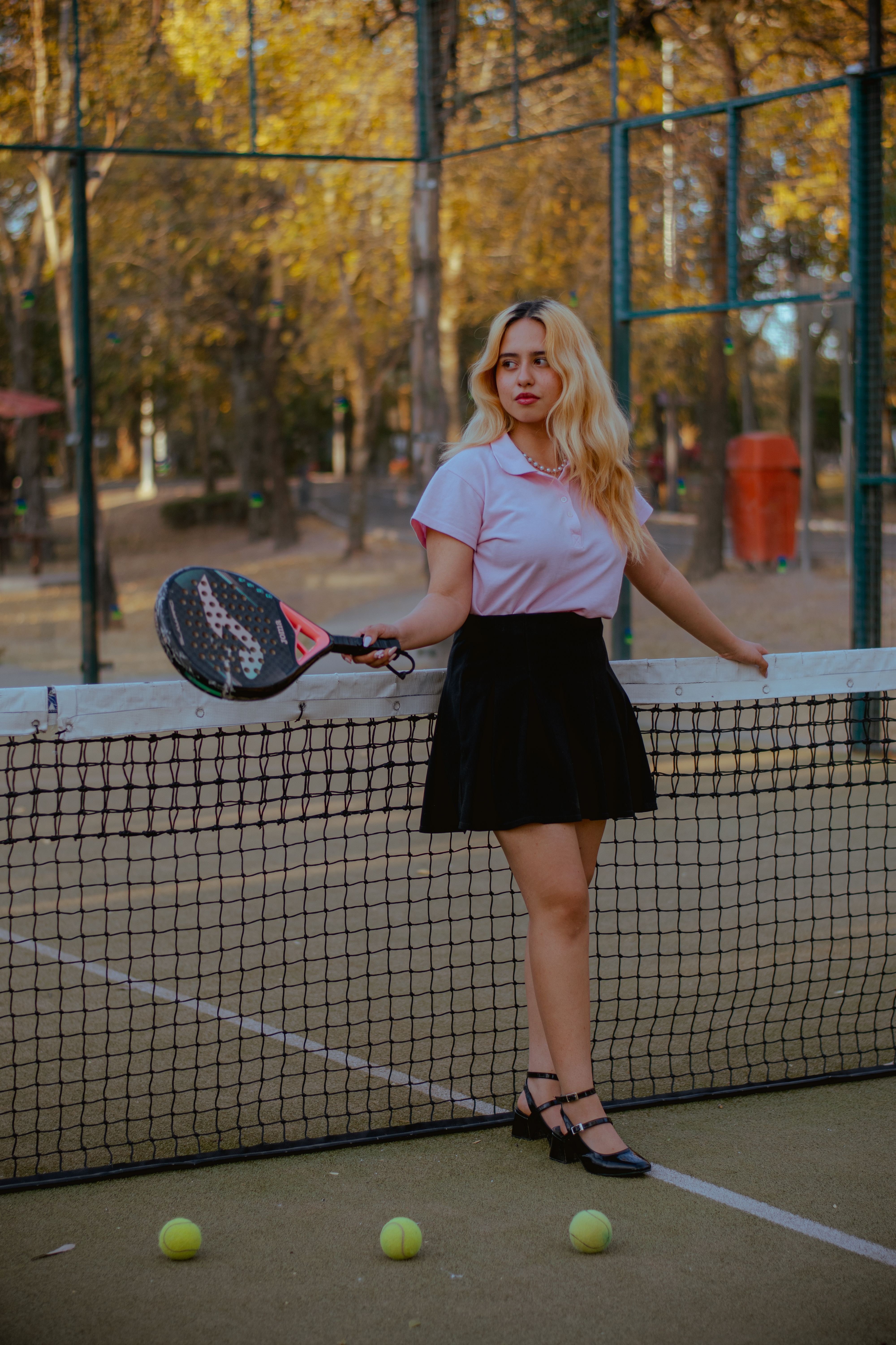 Woman in Tennis Outfit on Court with Autumn Leaves · Free Stock Photo