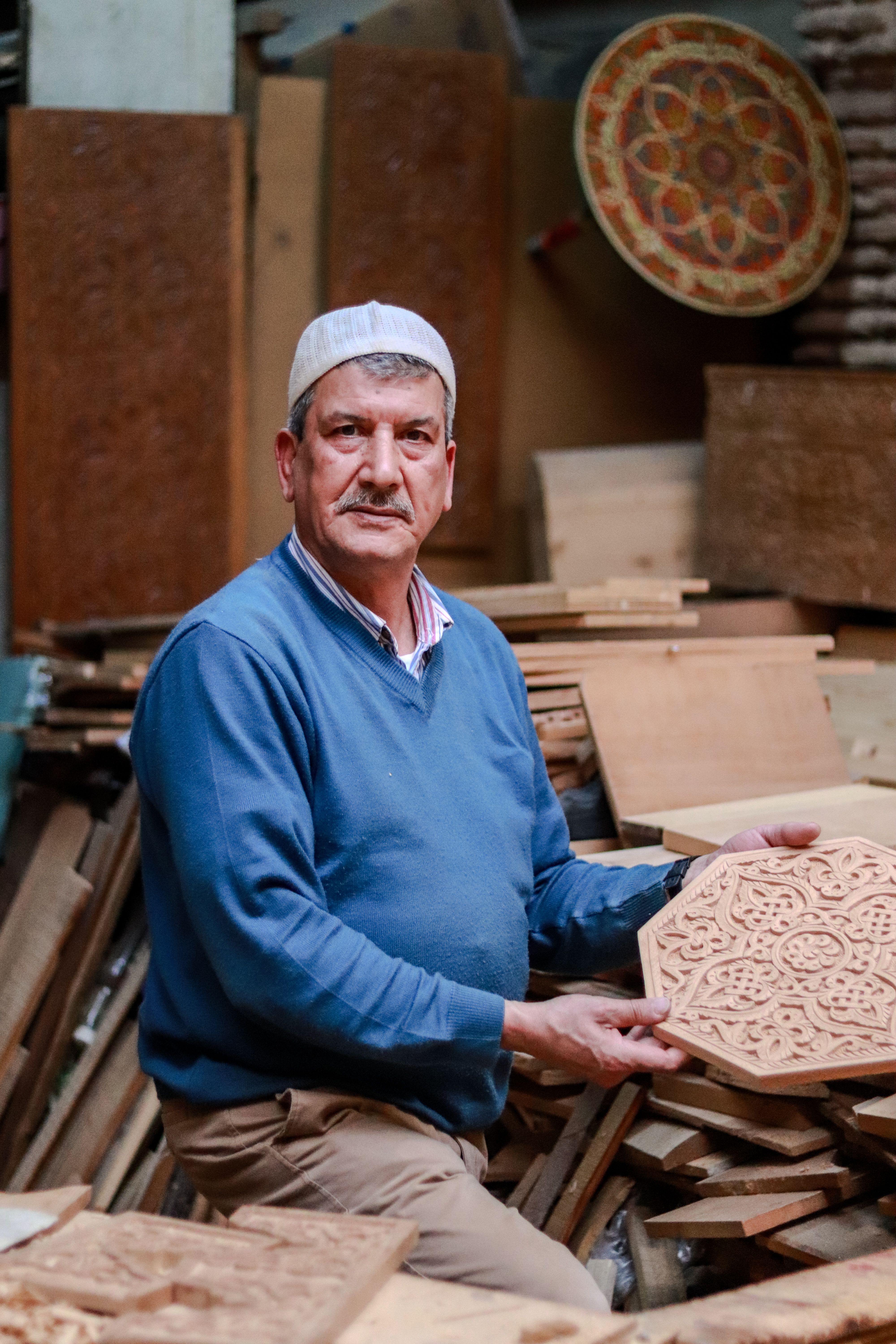 Middle Eastern craftsman with intricate woodwork · Free Stock Photo