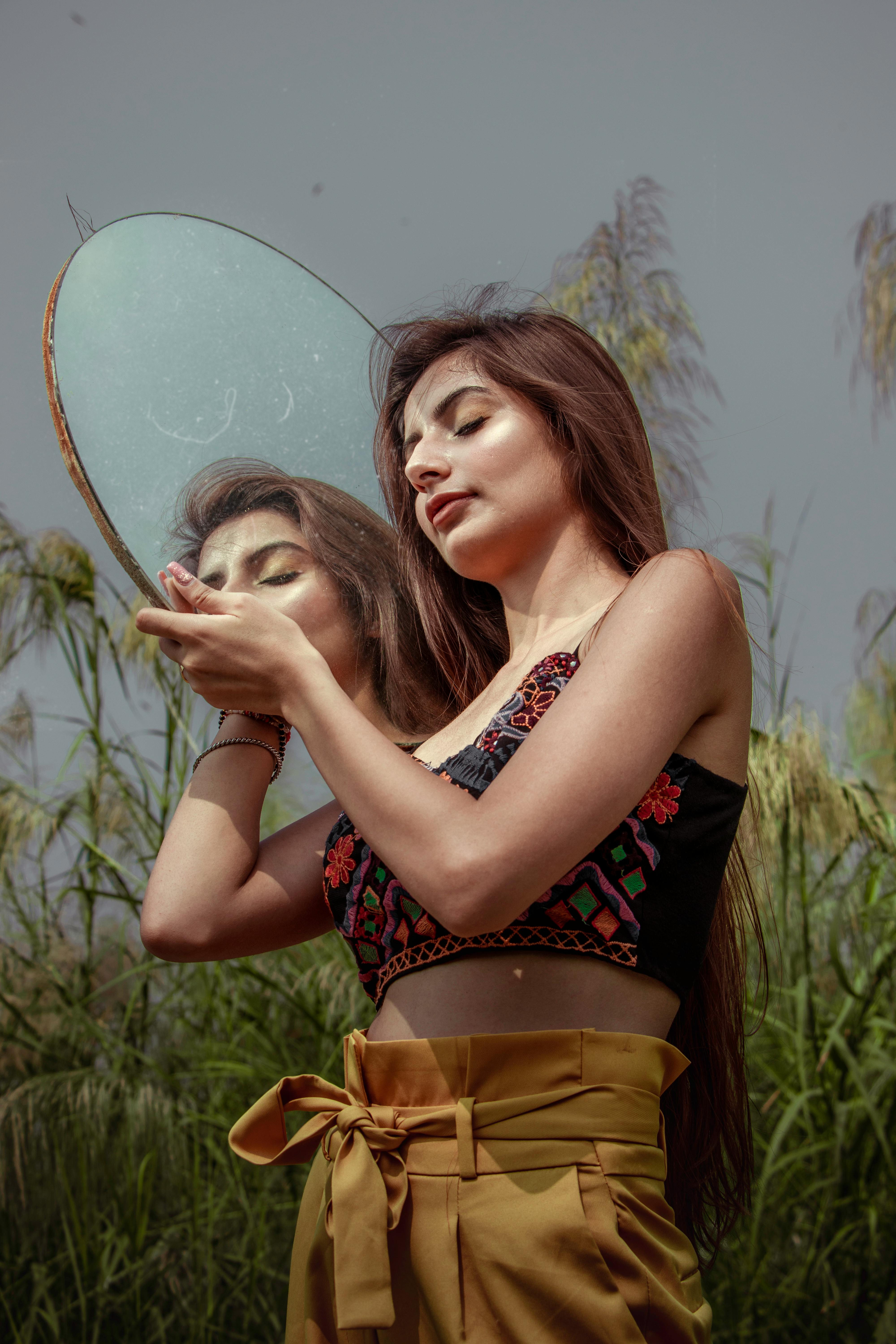Woman Holding a Mirror · Free Stock Photo