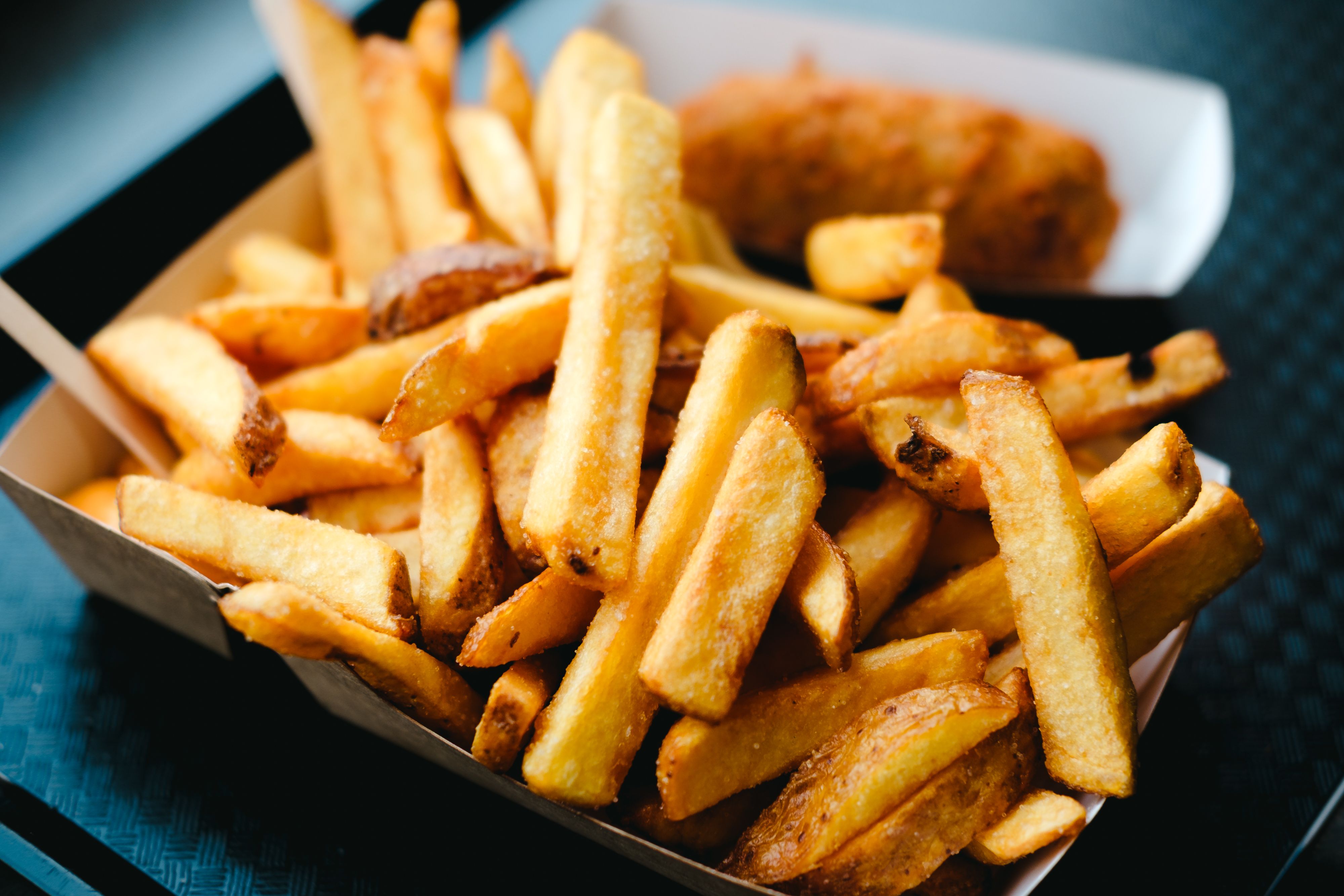 Crispy Golden French Fries in a Takeaway Box · Free Stock Photo