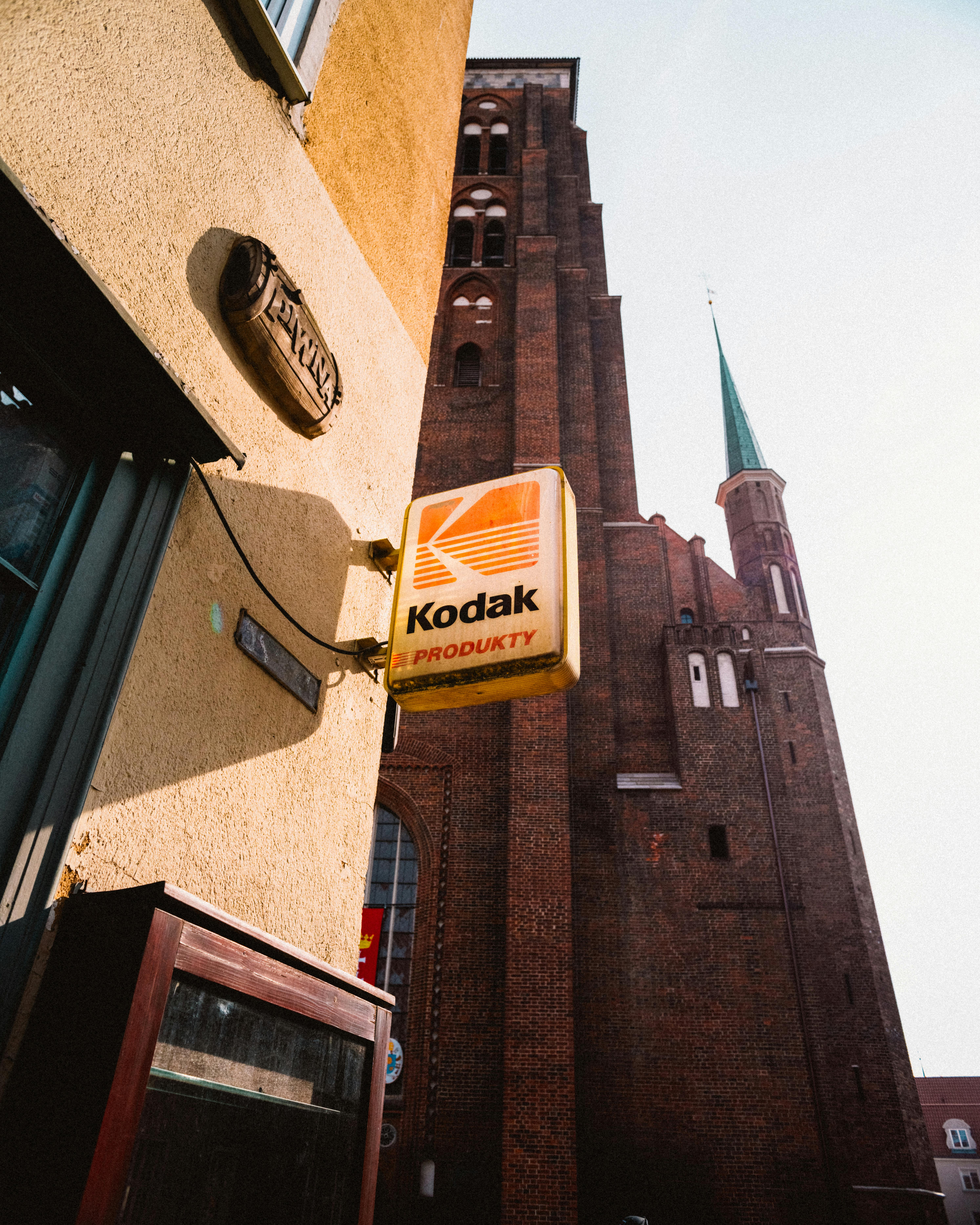 Vintage Kodak Sign by Historic European Church · Free Stock Photo