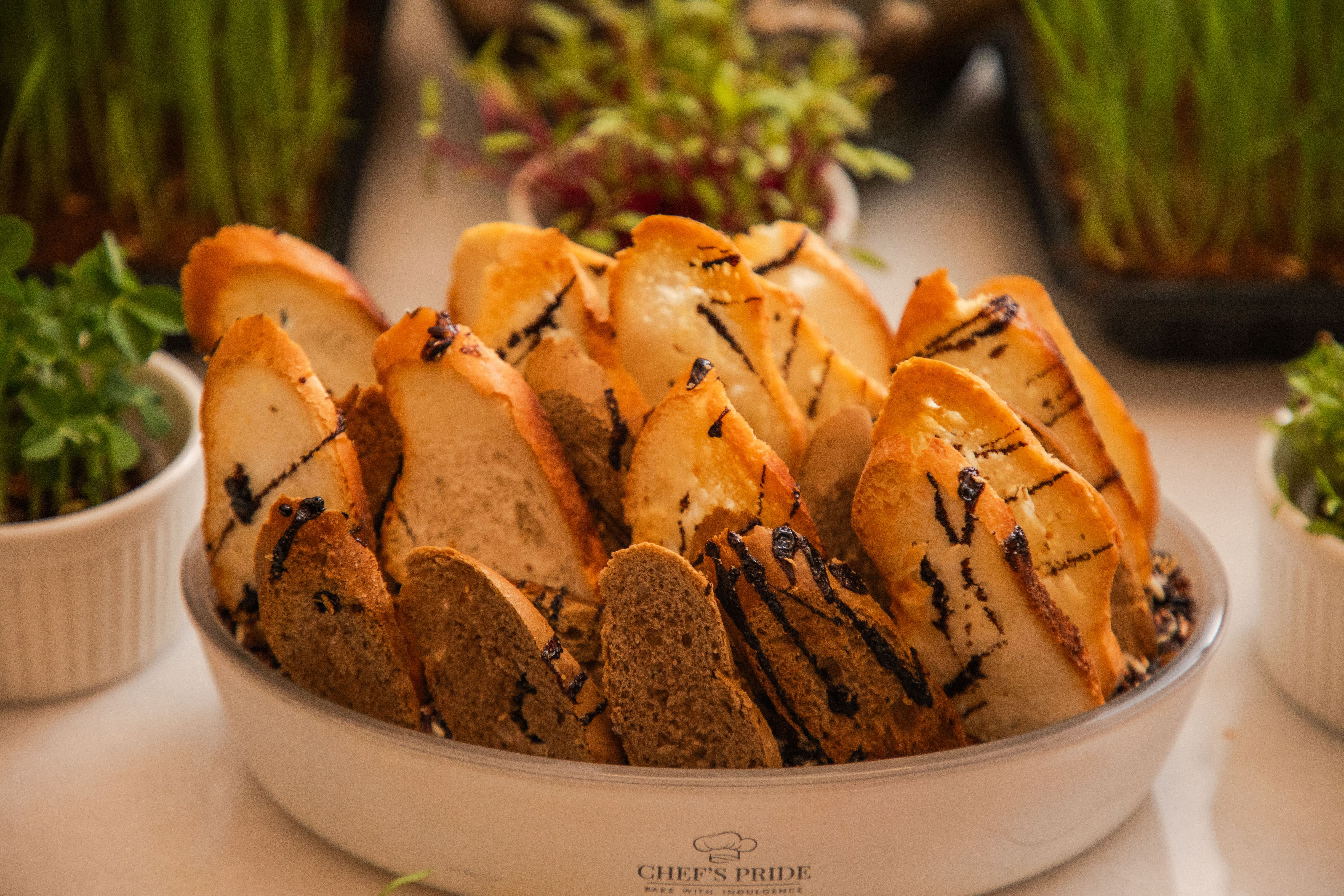 Gourmet Artisan Bread Display with Fresh Herbs · Free Stock Photo