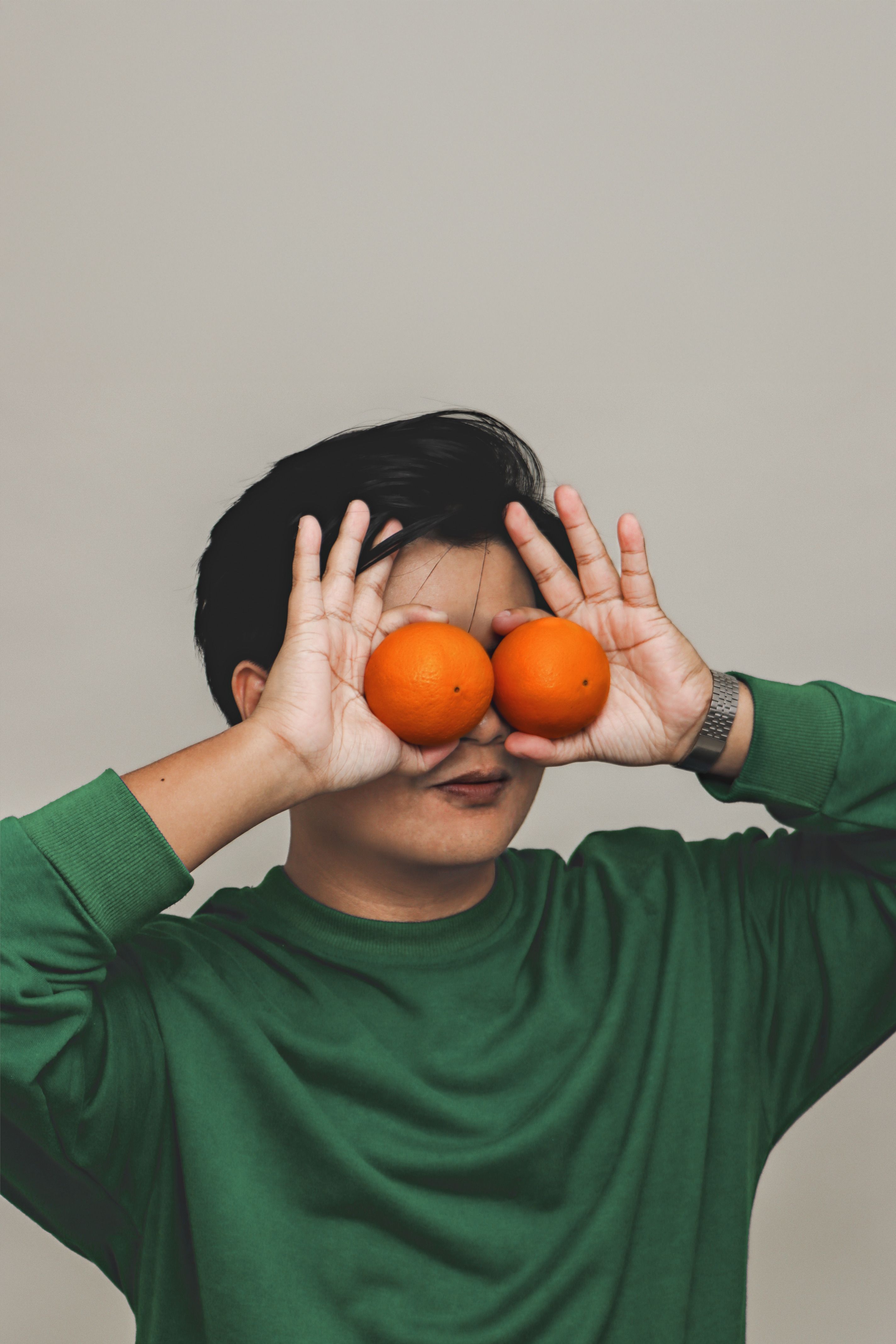 Playful Portrait with Oranges as Glasses Concept · Free Stock Photo