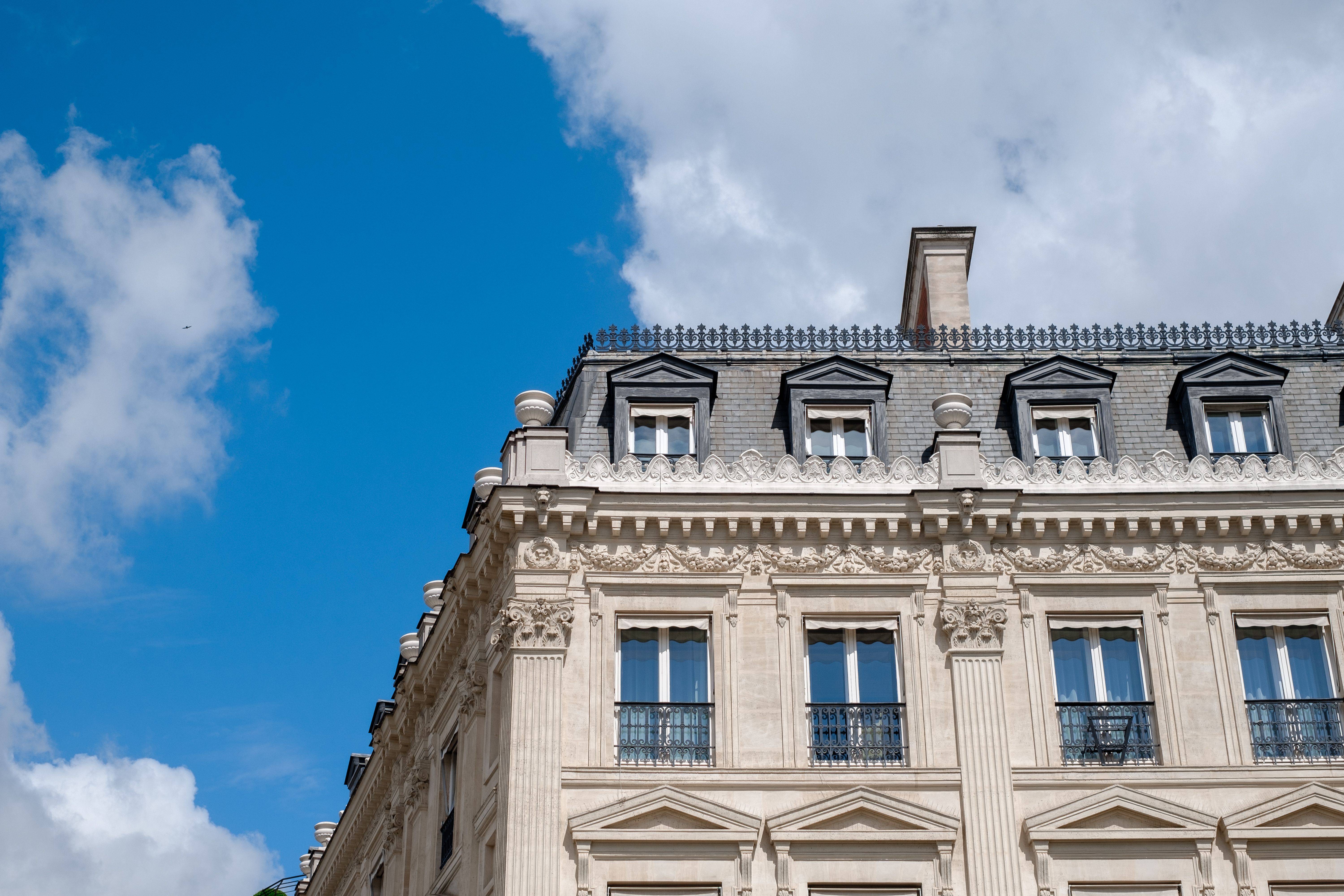 Elegant Parisian Building Against Blue Sky · Free Stock Photo