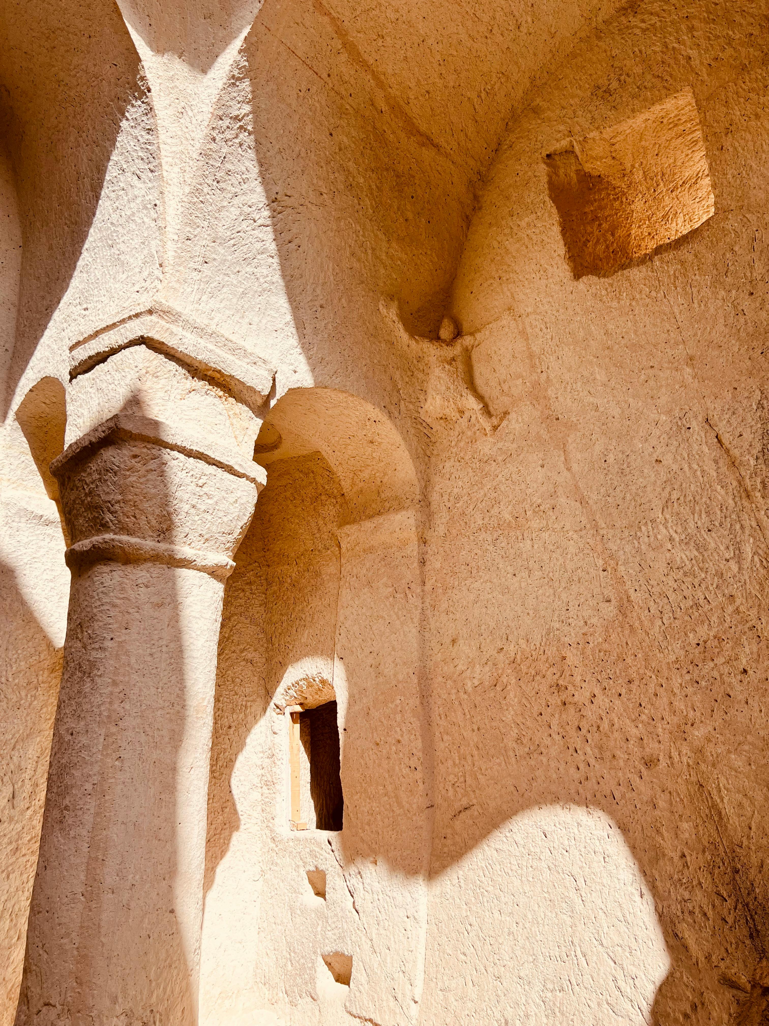 Ancient Cave Architecture with Sunlit Arches · Free Stock Photo