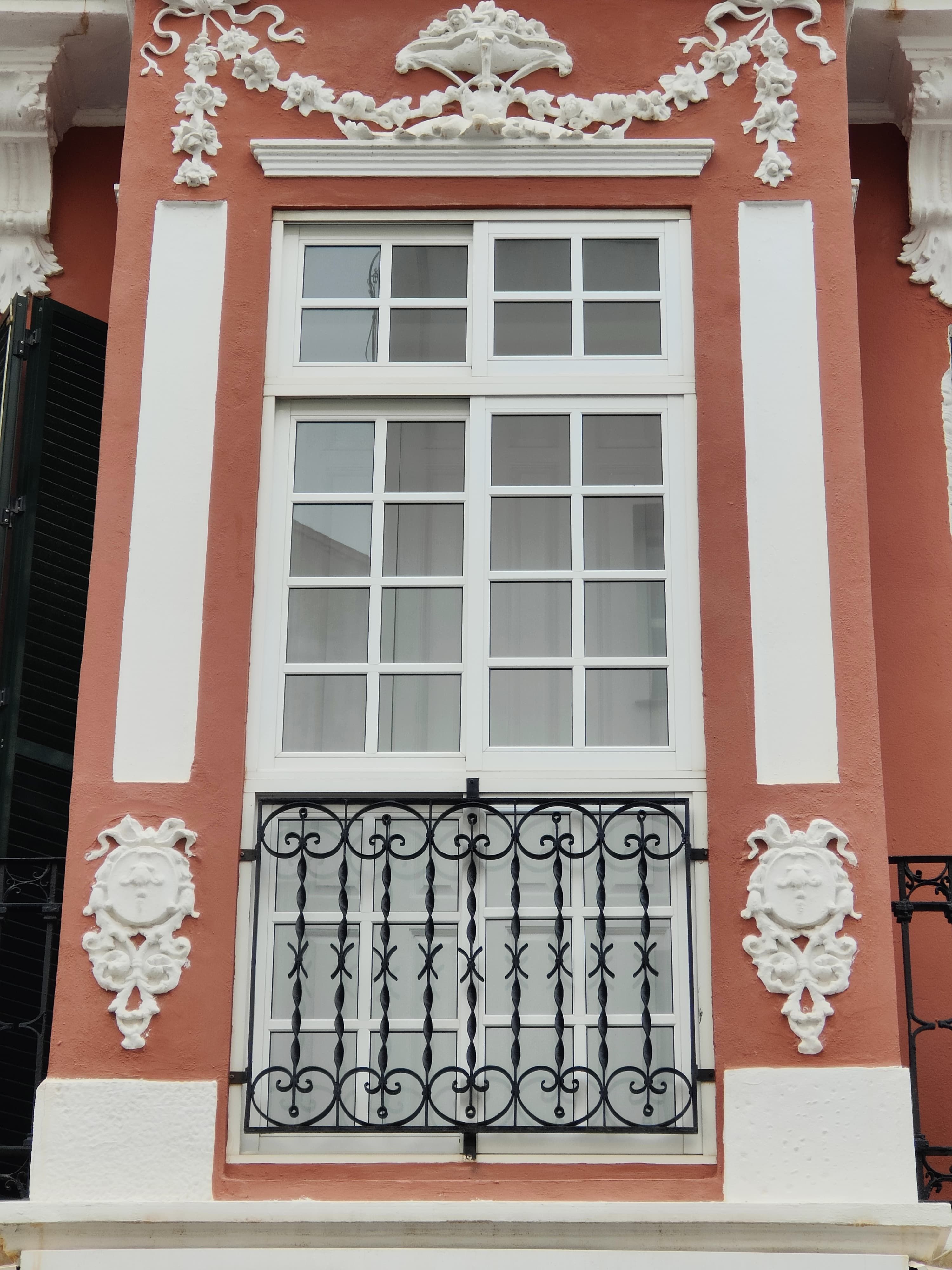 Ornate Salmon-Colored Building Facade with Balcony · Free Stock Photo