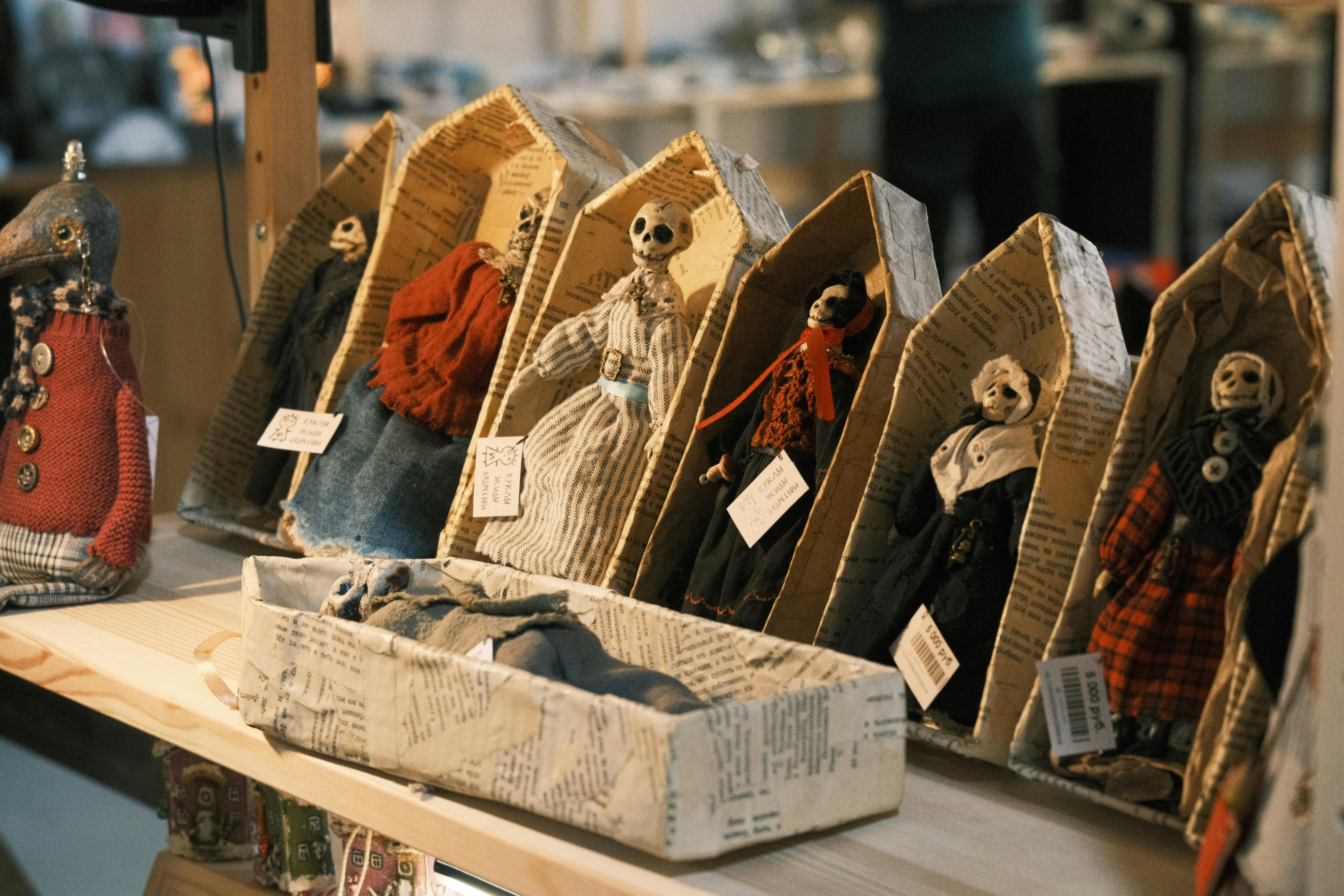 Handcrafted Skeleton Dolls on Display in Coffin Boxes · Free Stock Photo