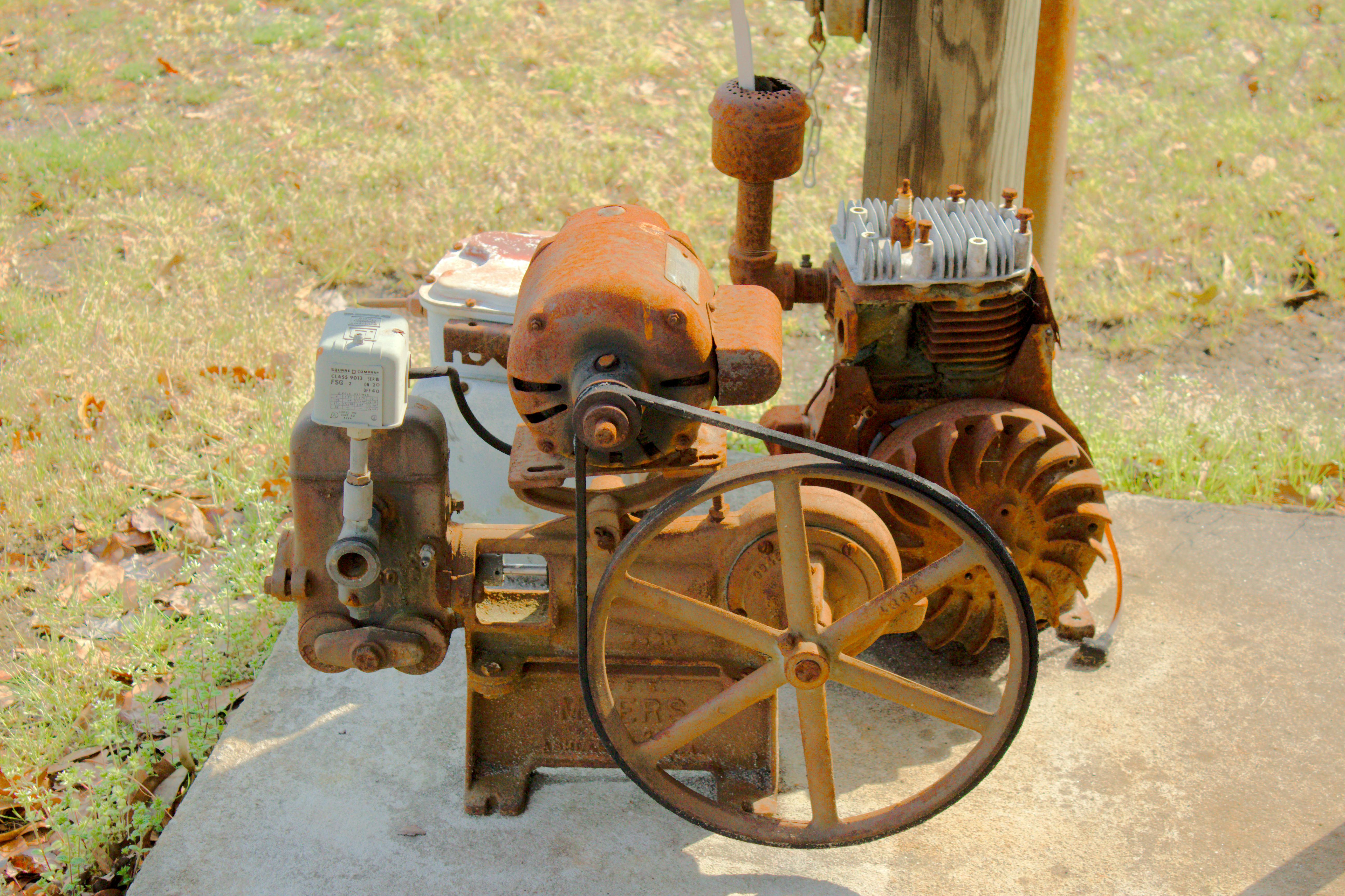 Rusty Old Machine on Concrete Platform Outdoors · Free Stock Photo