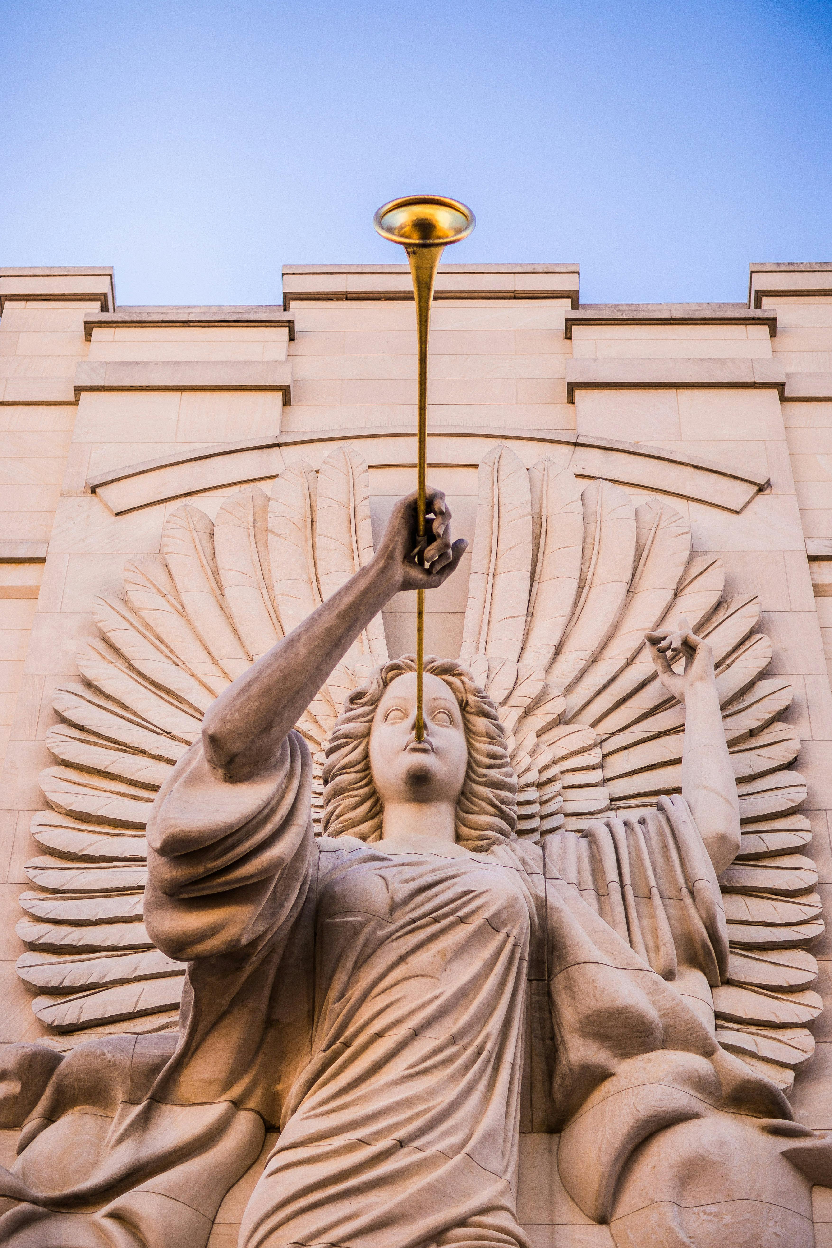 Photo Of A Statue Blowing Trumpet · Free Stock Photo