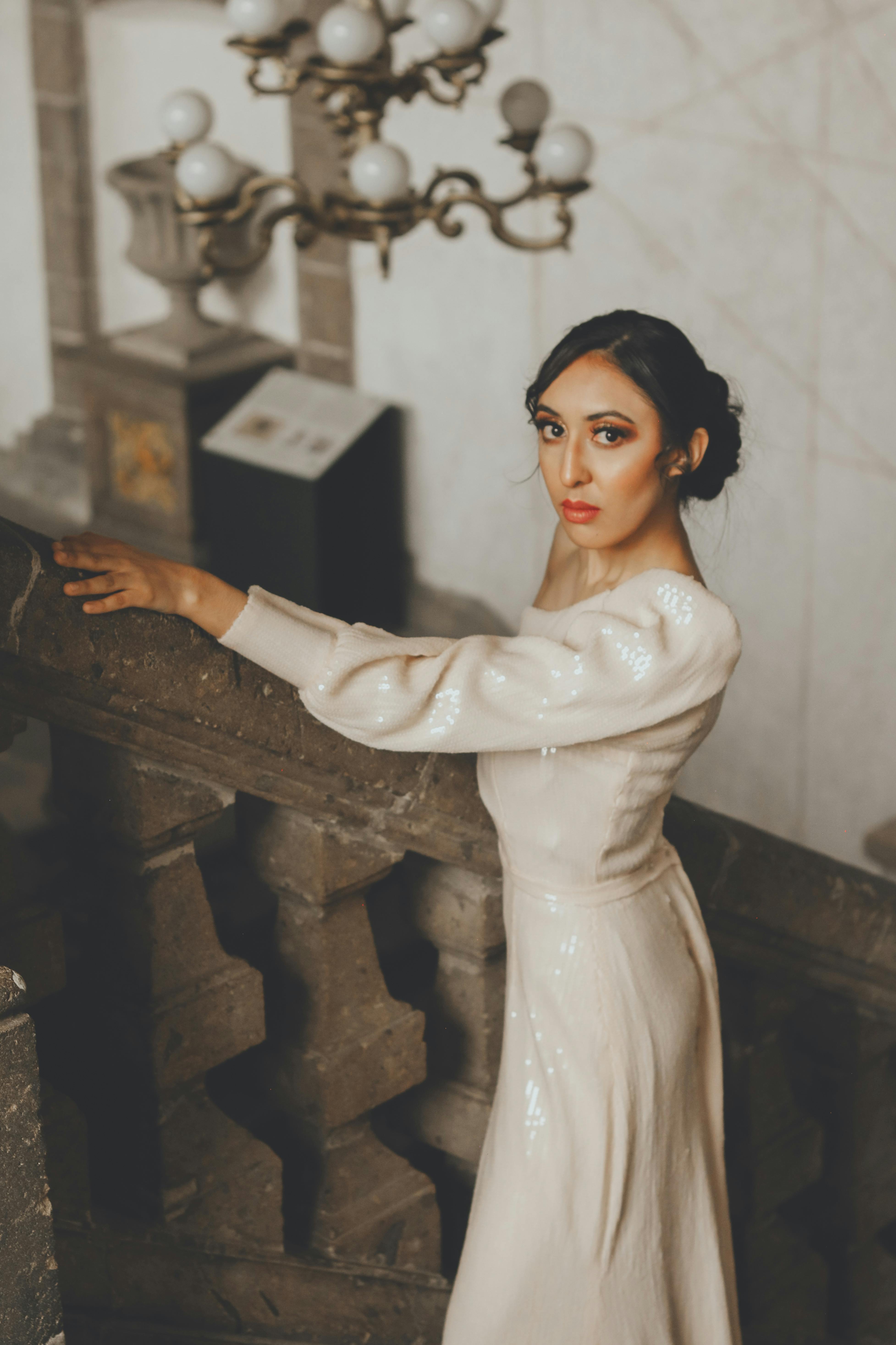 Elegant Woman on Vintage Staircase Portrait · Free Stock Photo