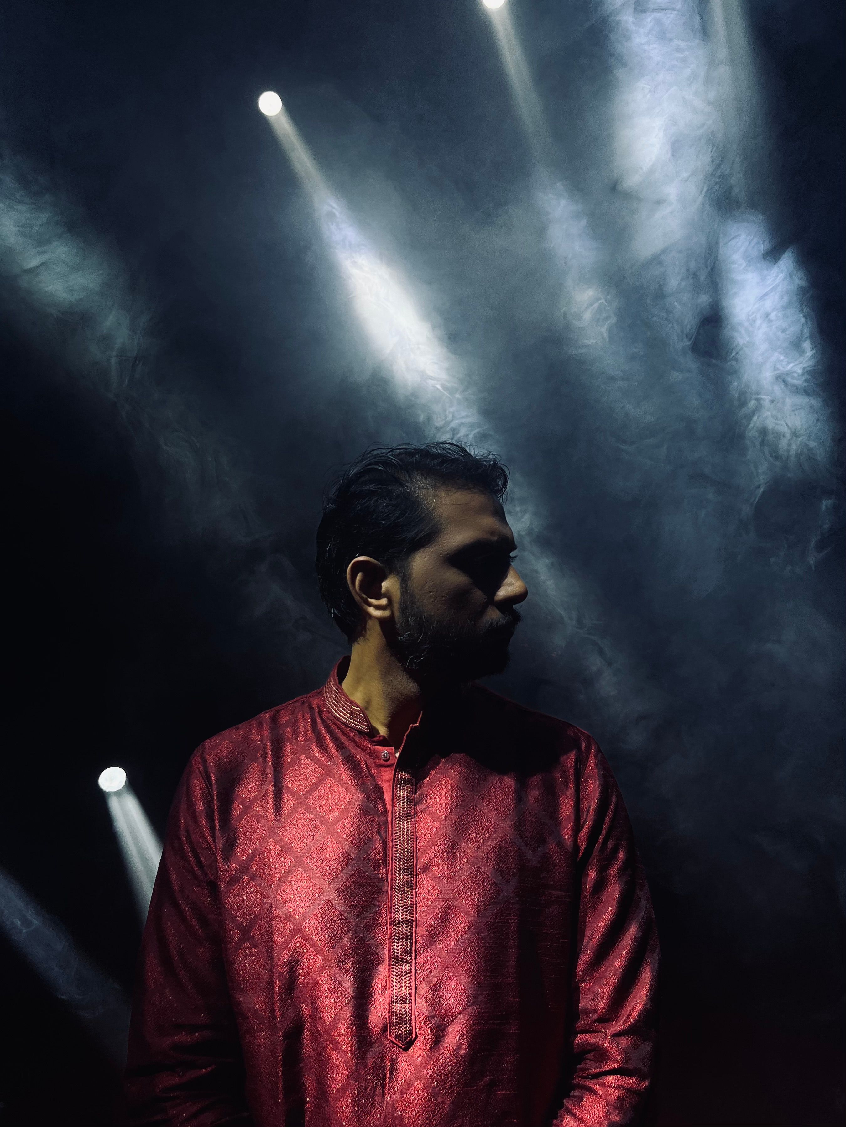 Dramatic Portrait with Spotlight on Man in Red · Free Stock Photo