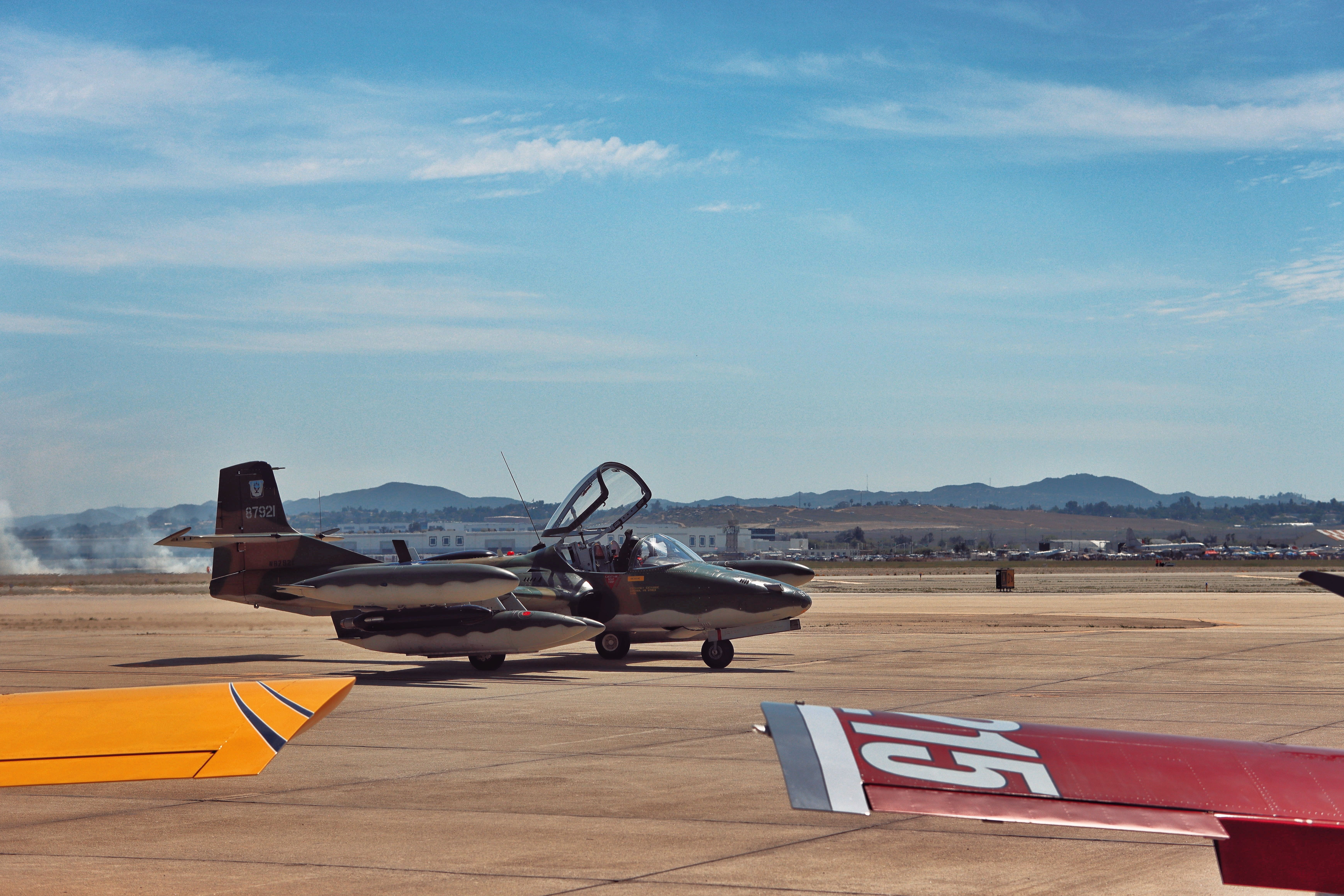 Vintage Military Jet on Runway with Clear Sky · Free Stock Photo
