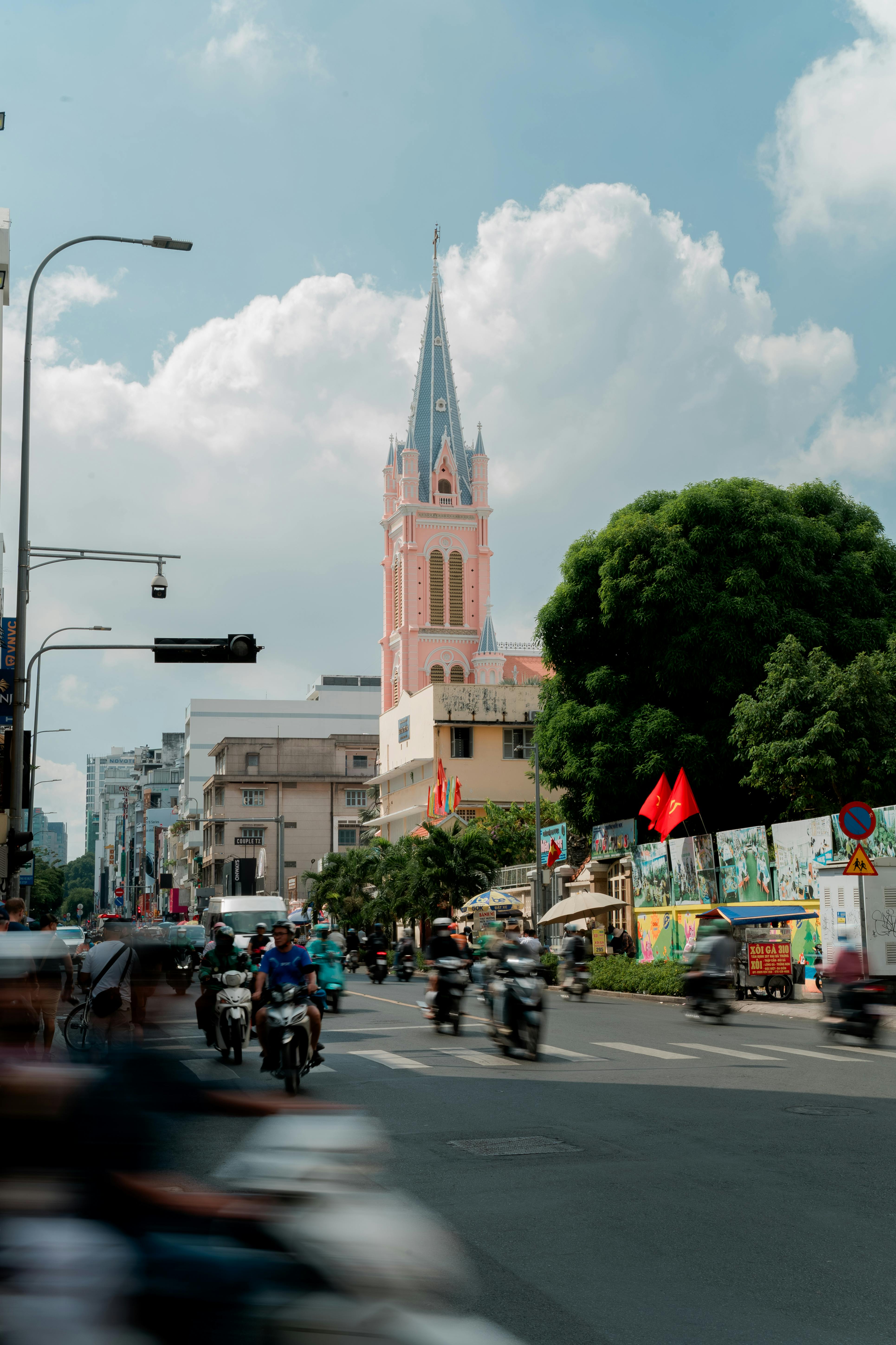 Bustling Saigon Street with Pink Church Spire · Free Stock Photo