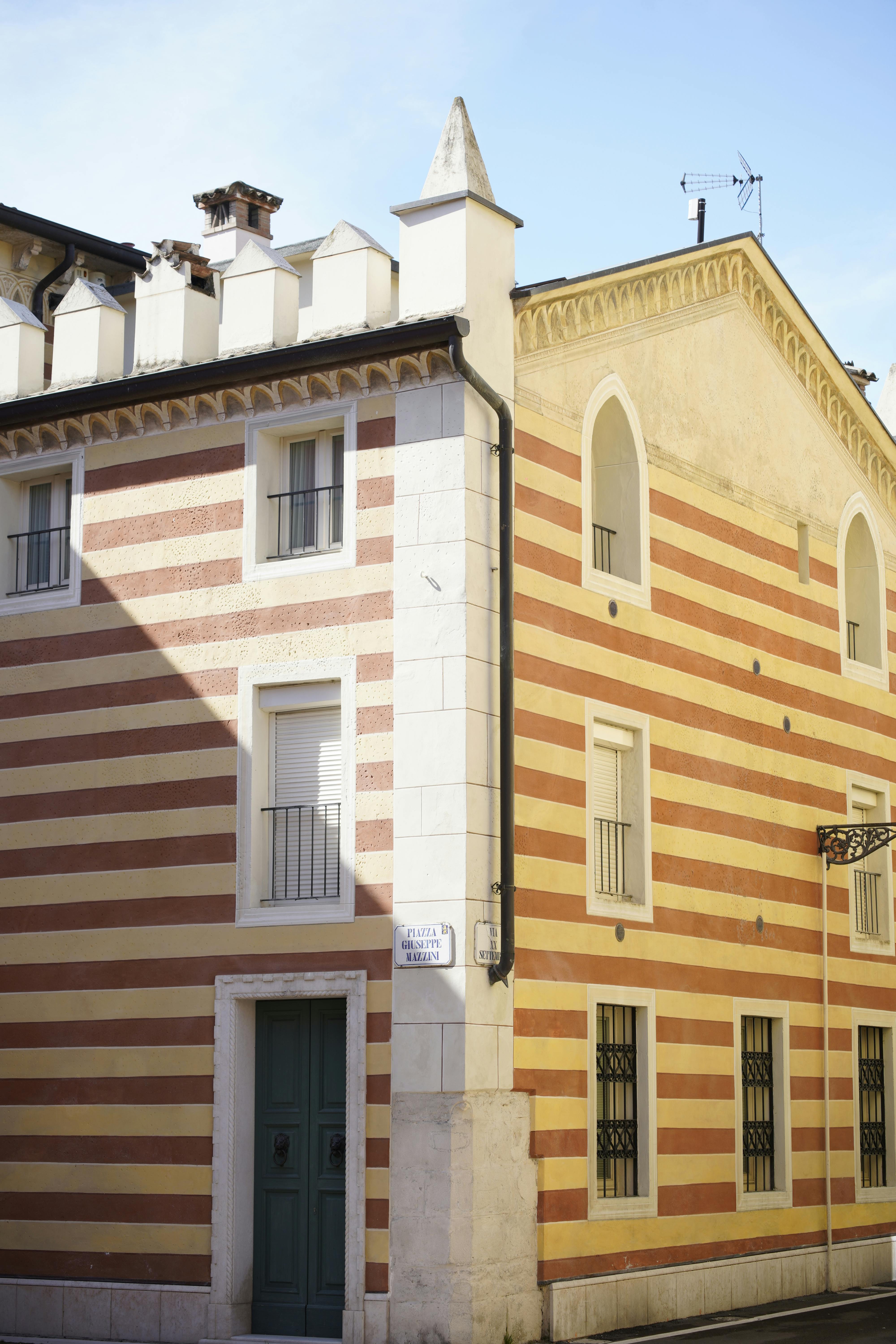 Colorful Striped Building in Italian Street Scene · Free Stock Photo